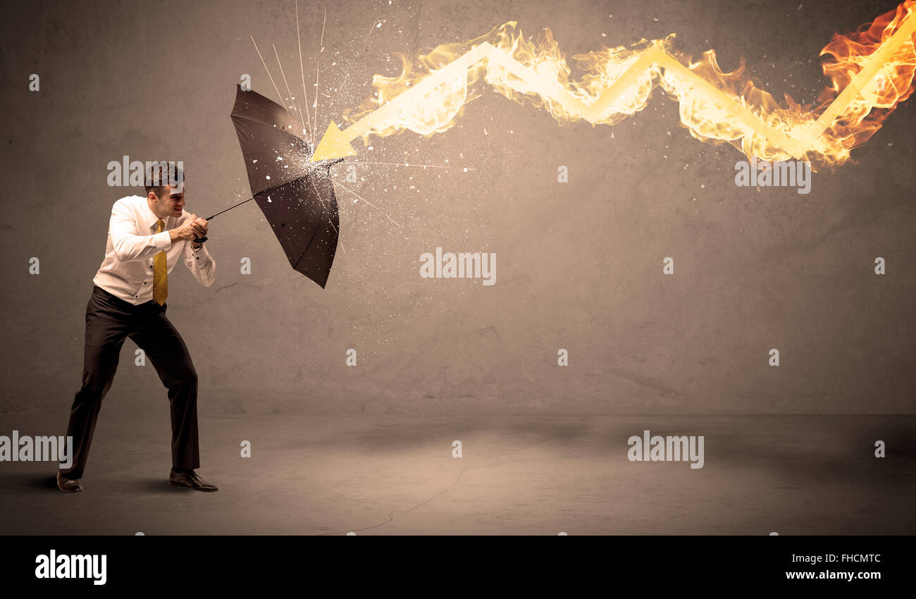 Business man defending himself from a fire arrow with an umbrella Stock ...