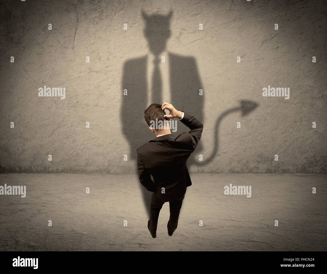 Salesman facing his own devil shadow Stock Photo - Alamy