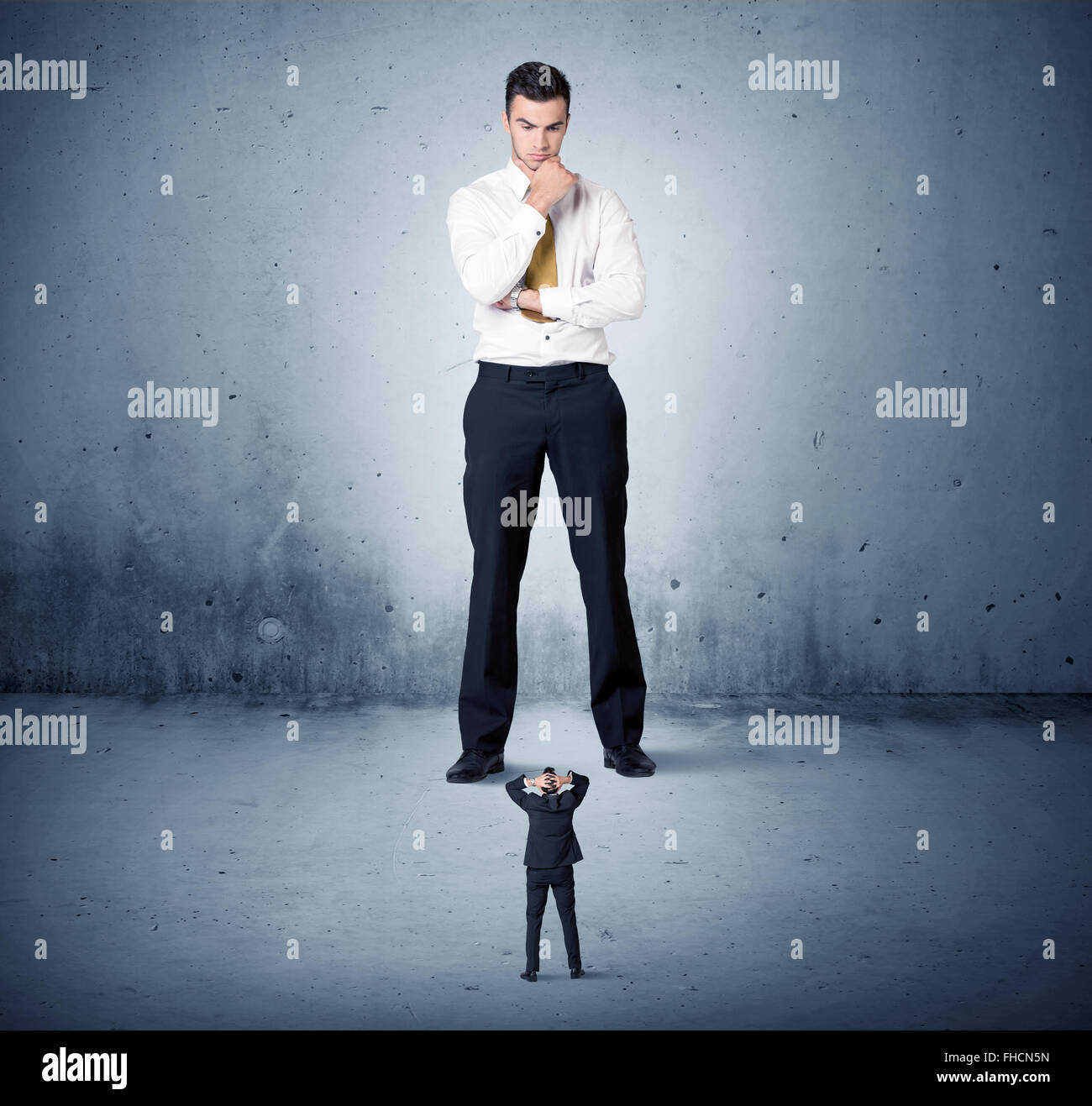 Angry huge business man lokking at small guy Stock Photo - Alamy