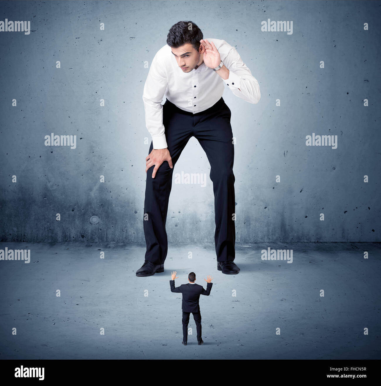 Angry huge business man lokking at small guy Stock Photo - Alamy