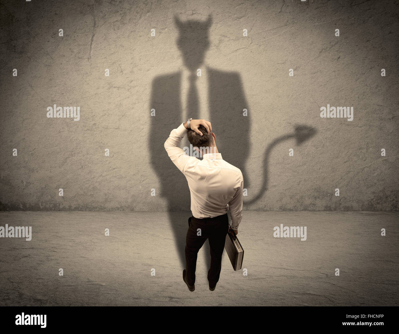 Salesman facing his own devil shadow Stock Photo - Alamy