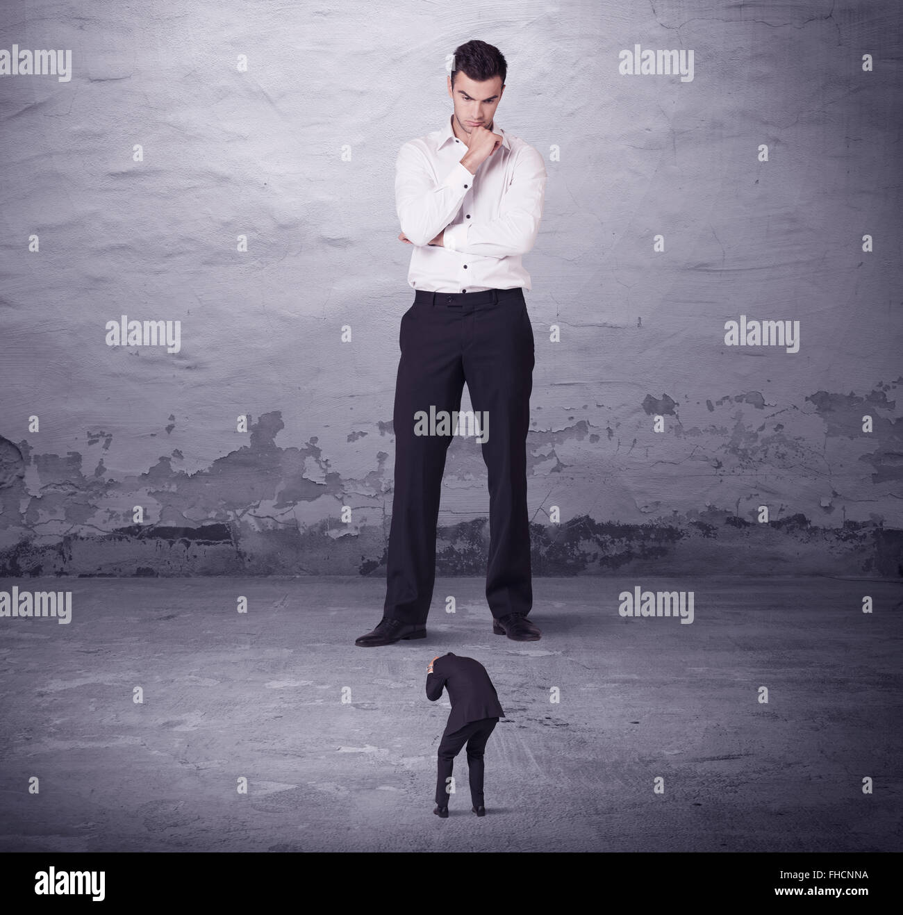 Angry big manager looking at small business man Stock Photo - Alamy