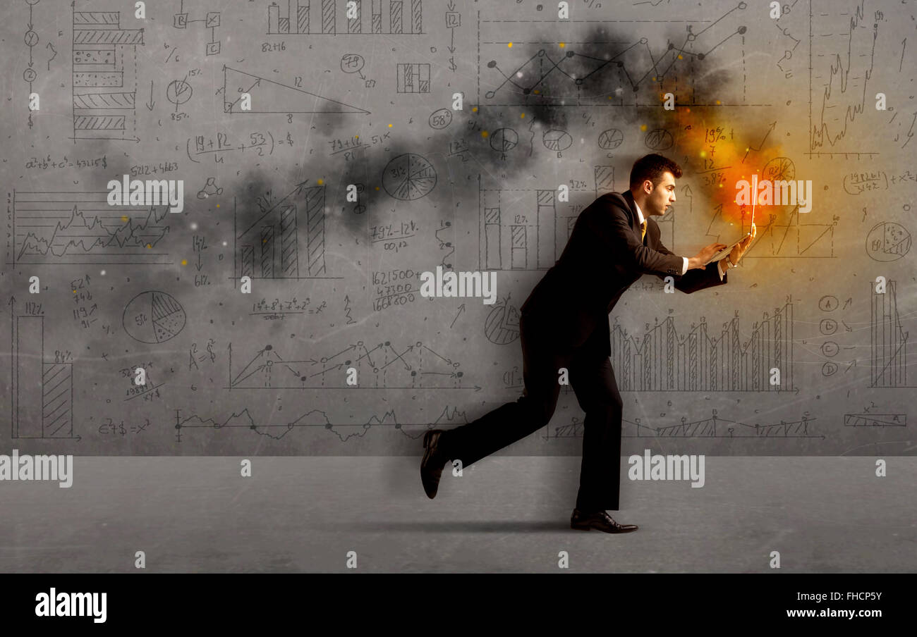 Running business man with fire laptop Stock Photo - Alamy