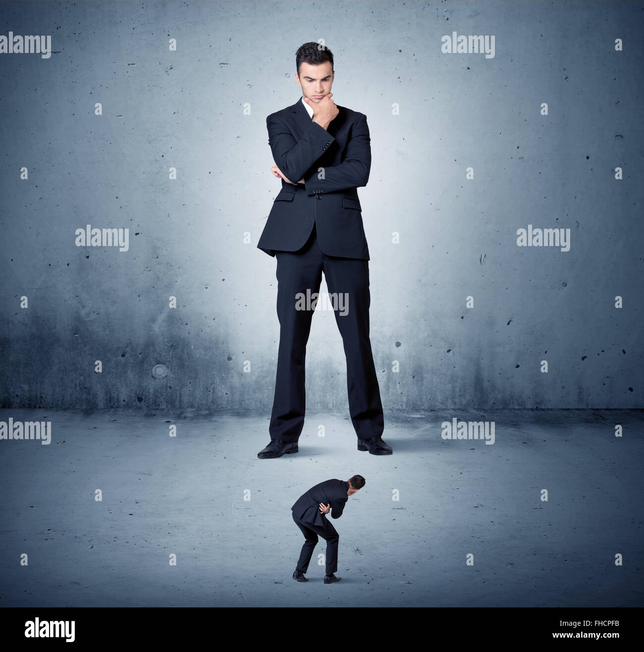 Angry huge business man lokking at small guy Stock Photo - Alamy