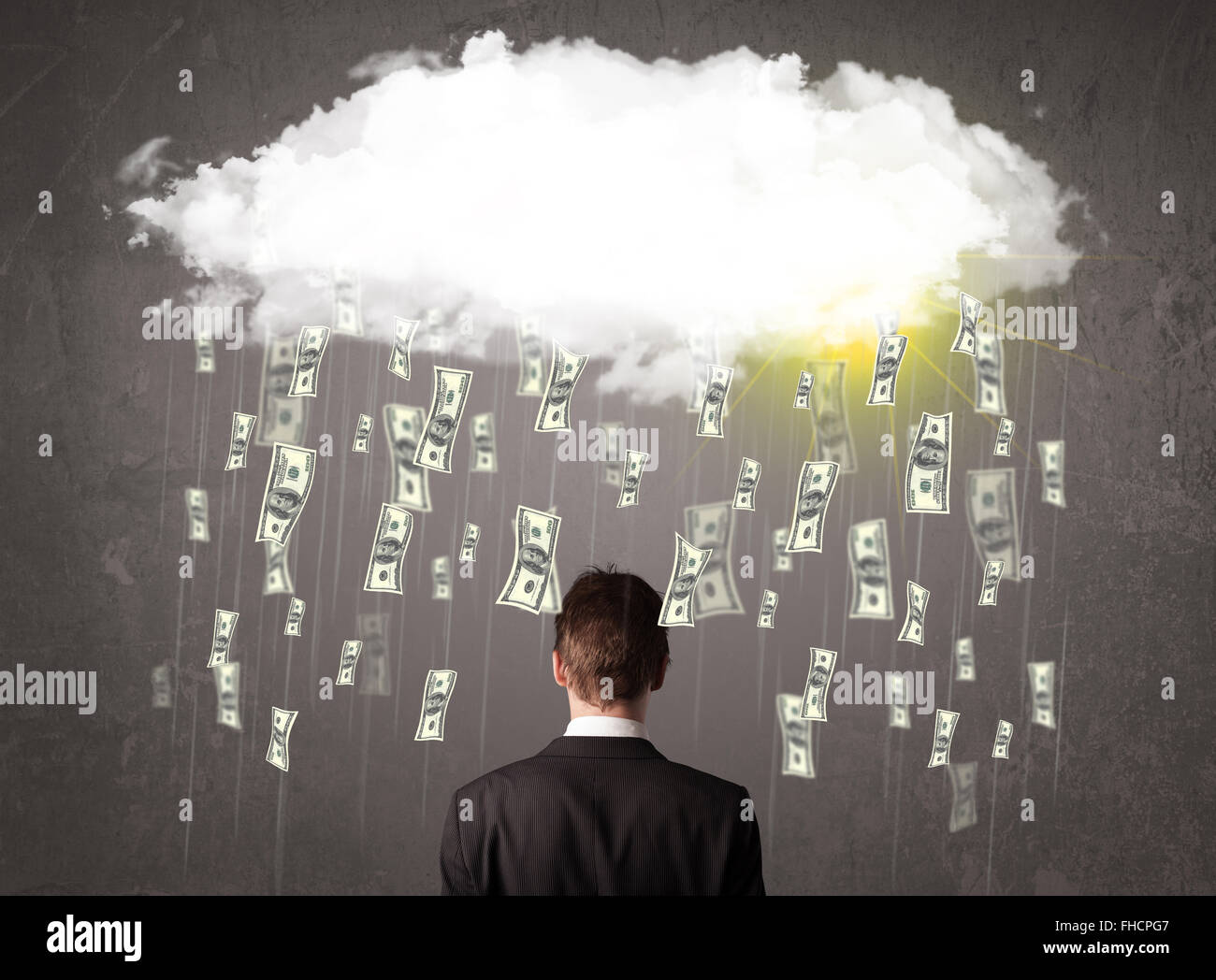 Business man in suit looking at cloud with falling money Stock Photo ...