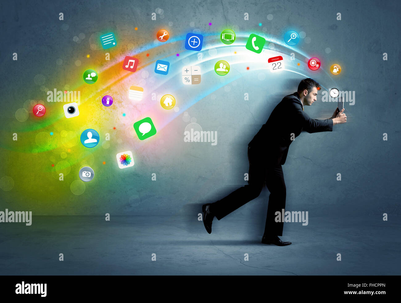 Running businessman with application icons from device Stock Photo - Alamy