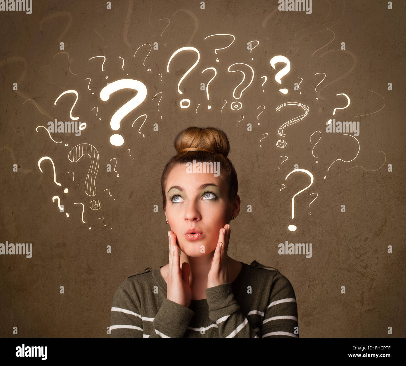 girl with question mark symbols around her head Stock Photo - Alamy
