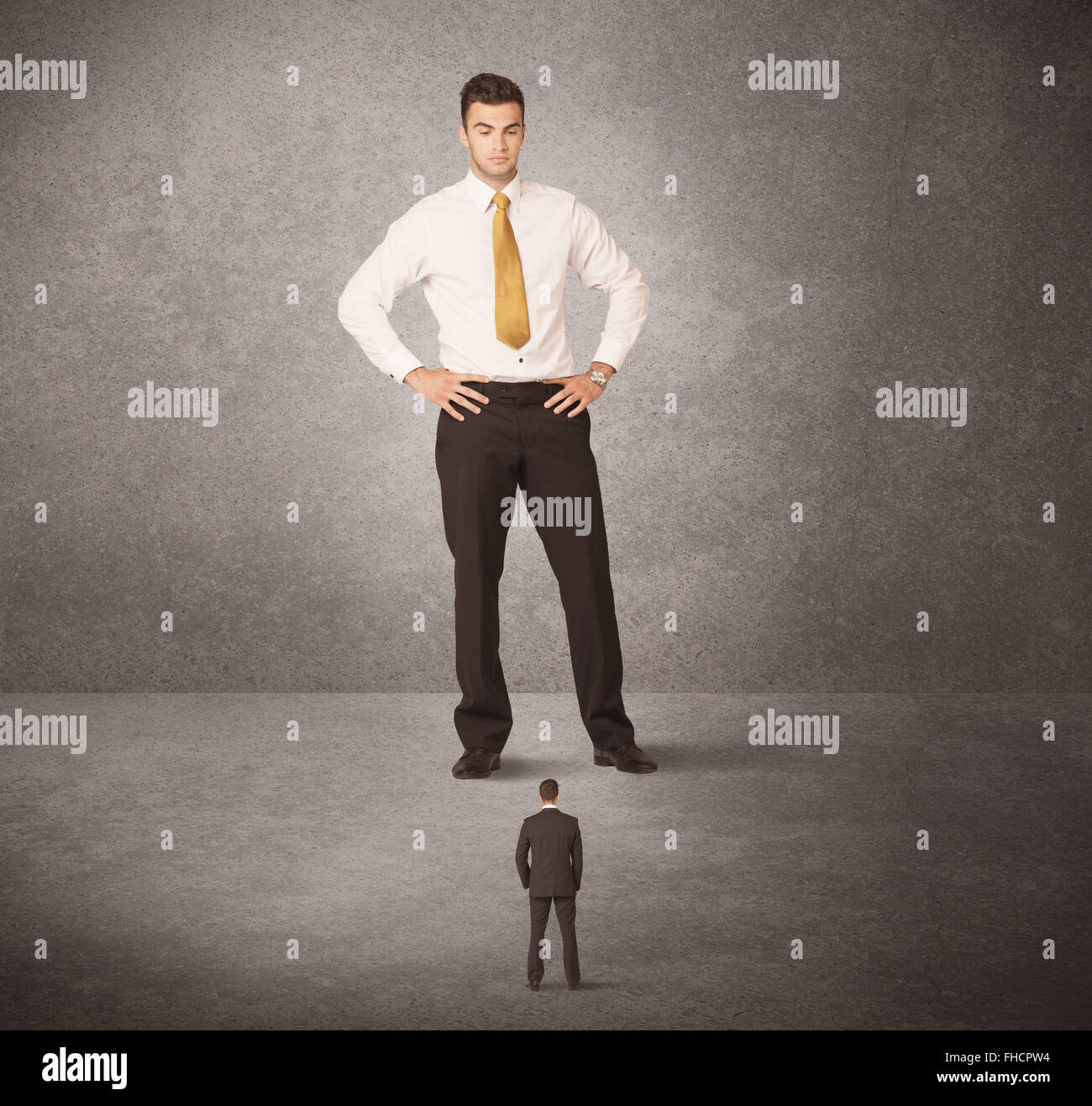 Big business man looking at small worker Stock Photo - Alamy