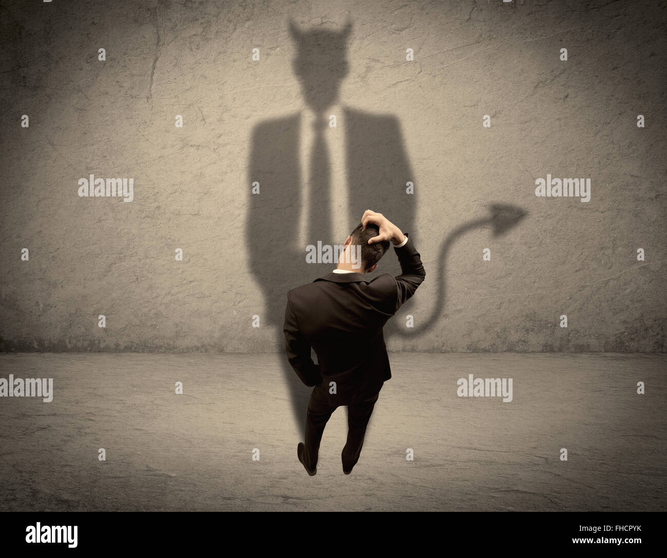 Salesman facing his own devil shadow Stock Photo - Alamy