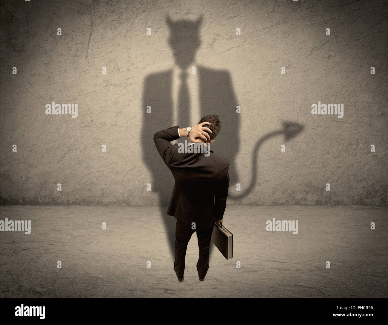 Salesman facing his own devil shadow Stock Photo - Alamy