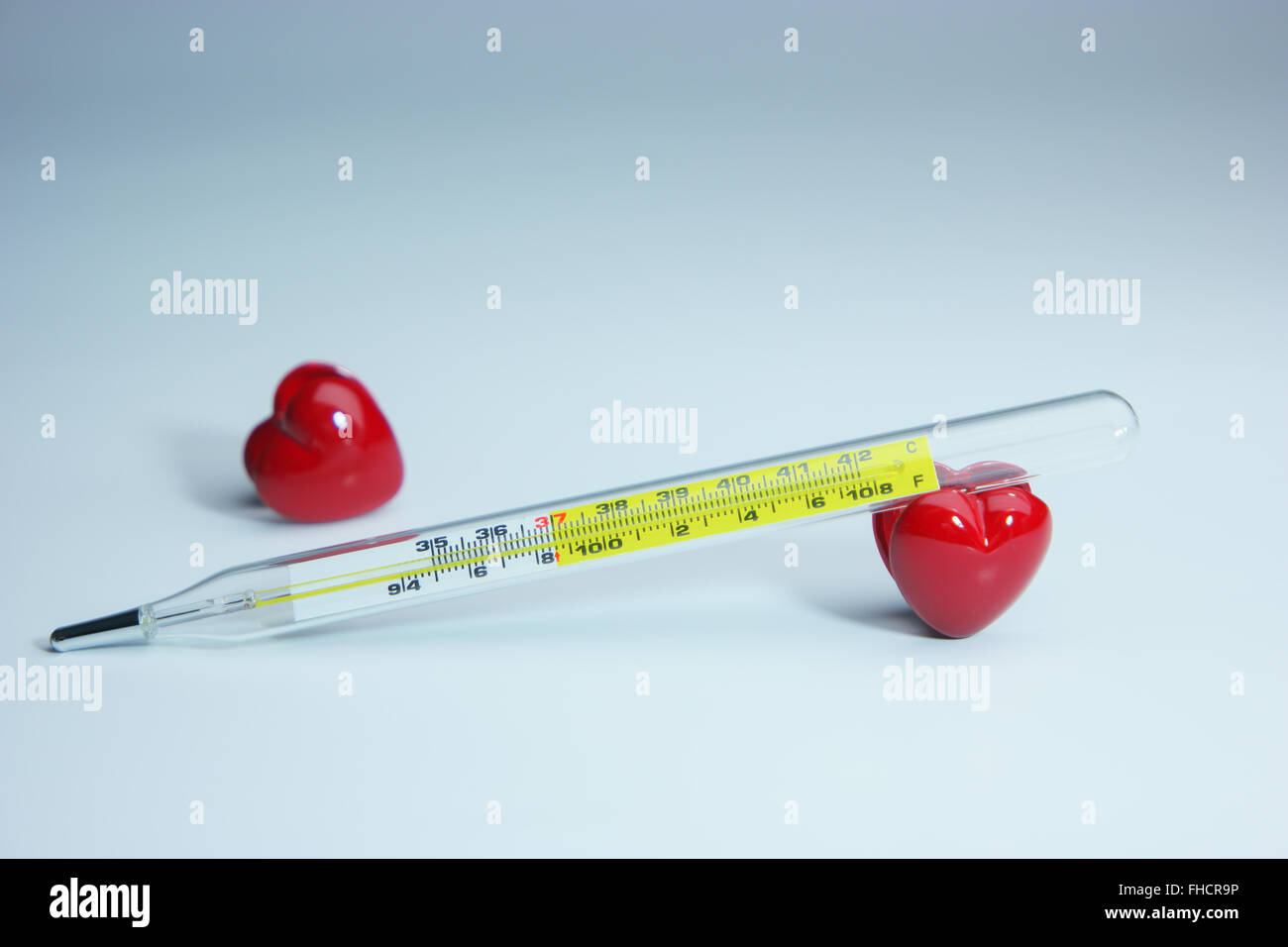 Heart with thermometer Stock Photo - Alamy