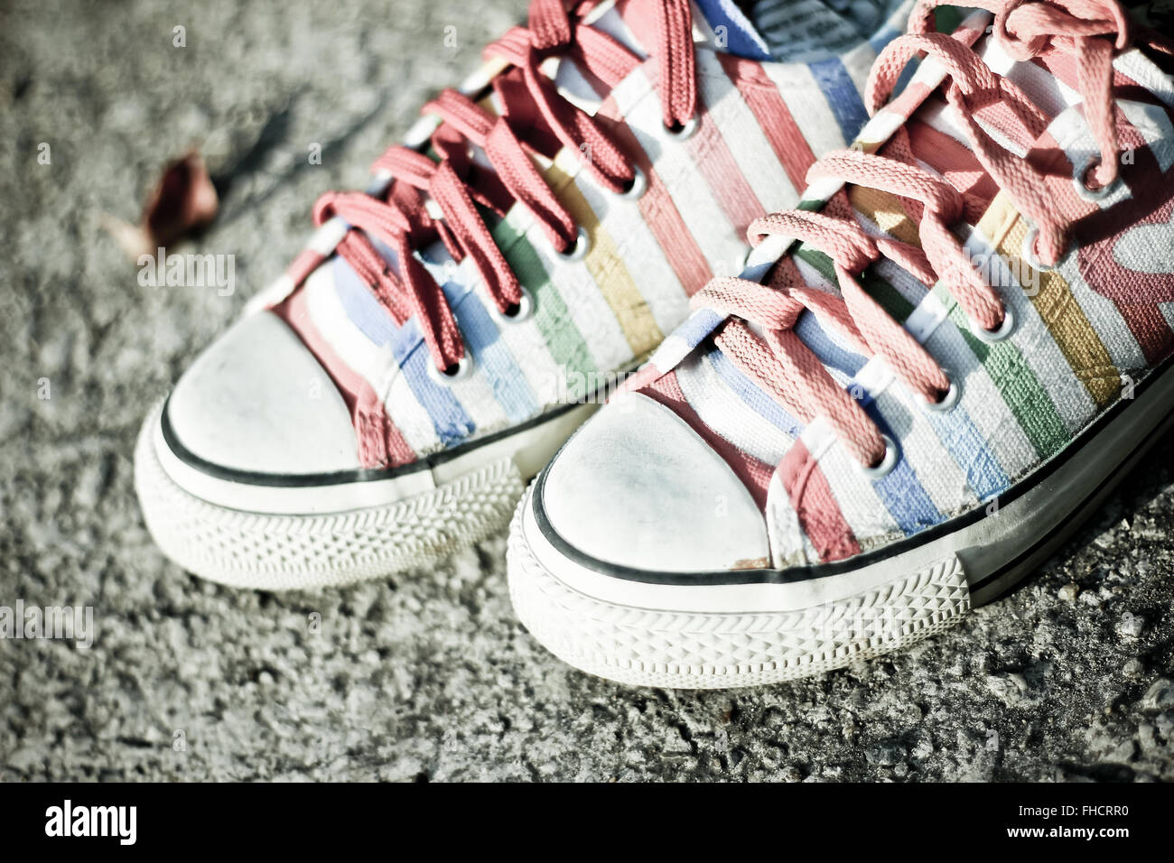 Colour canvas shoes in vintage filter style Stock Photo - Alamy