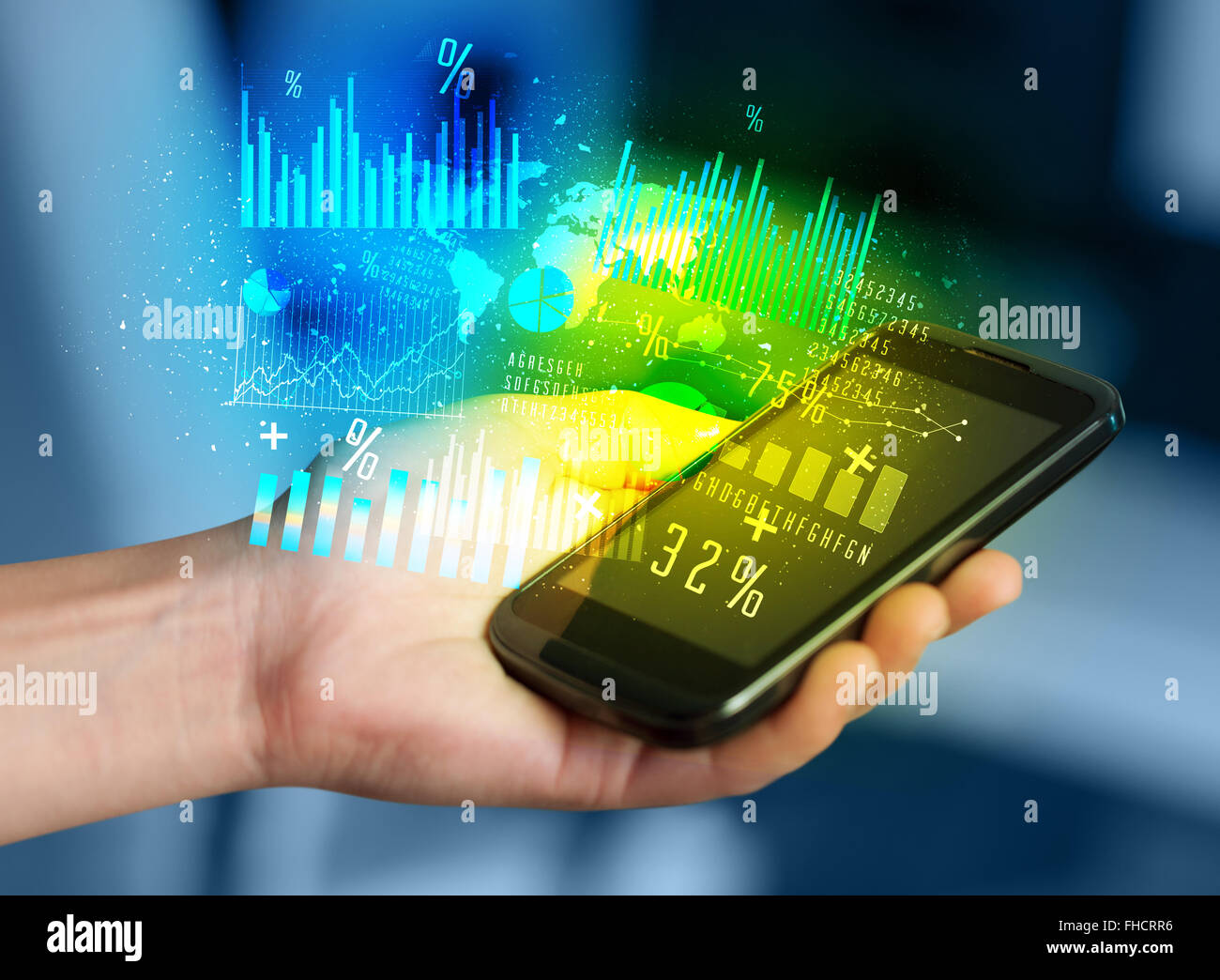 Hand holding smartphone with business diagrams Stock Photo - Alamy