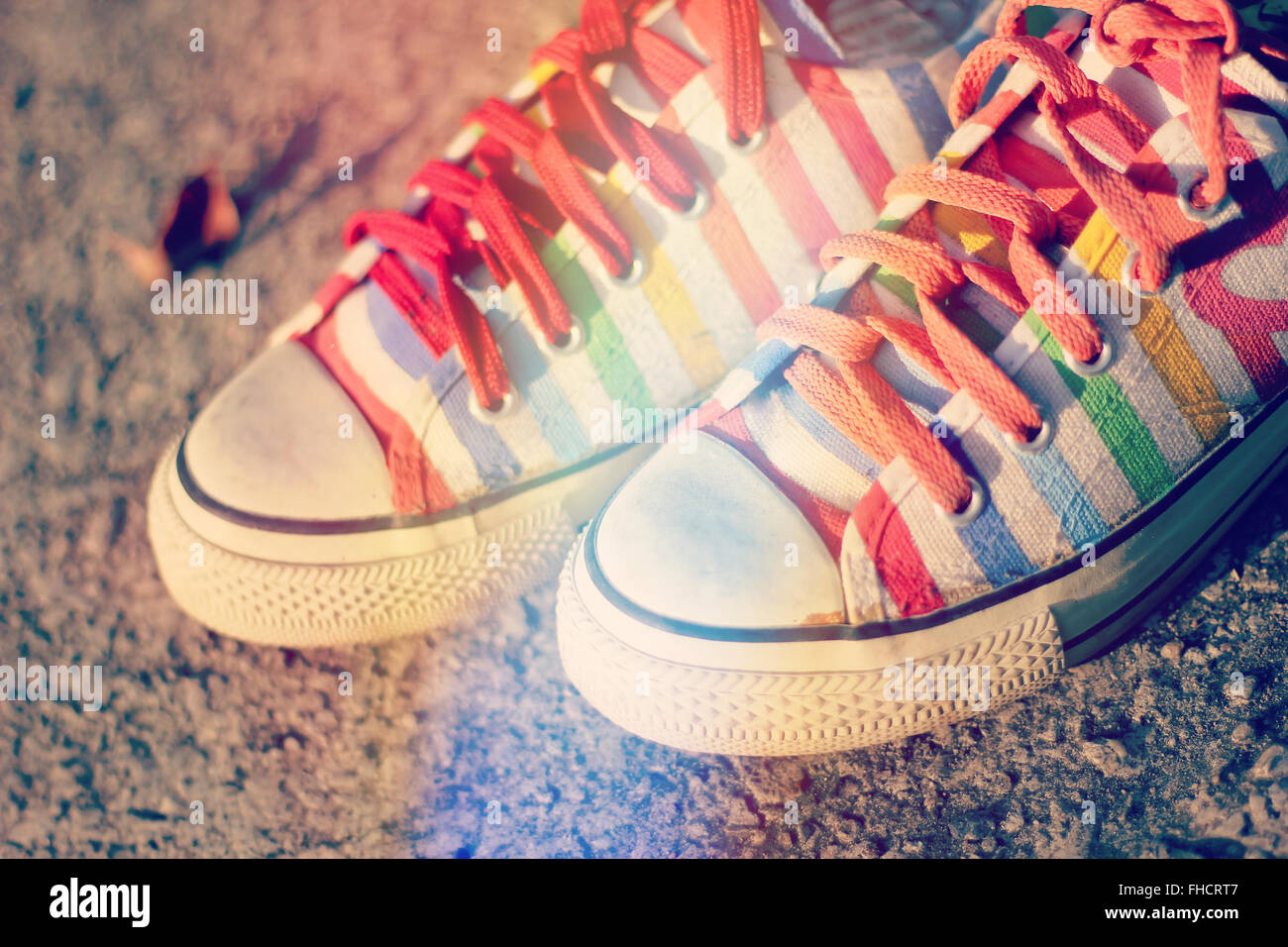 Colour canvas shoes in vintage filter style Stock Photo - Alamy