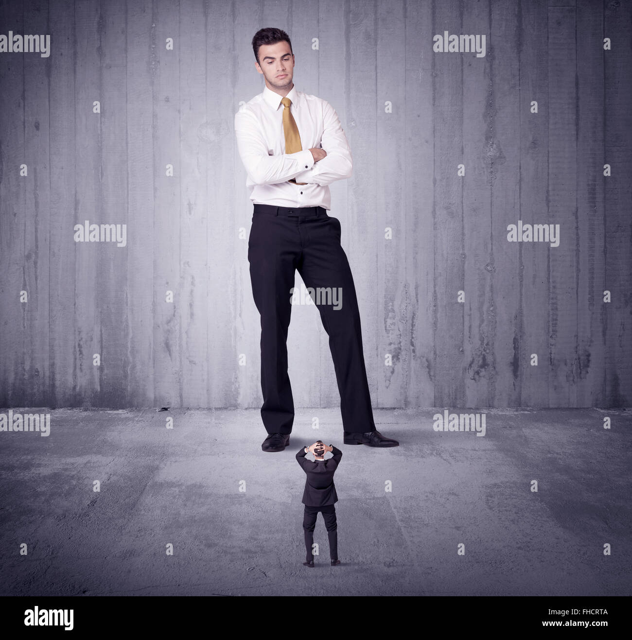 Huge boss lokking at small business man Stock Photo - Alamy