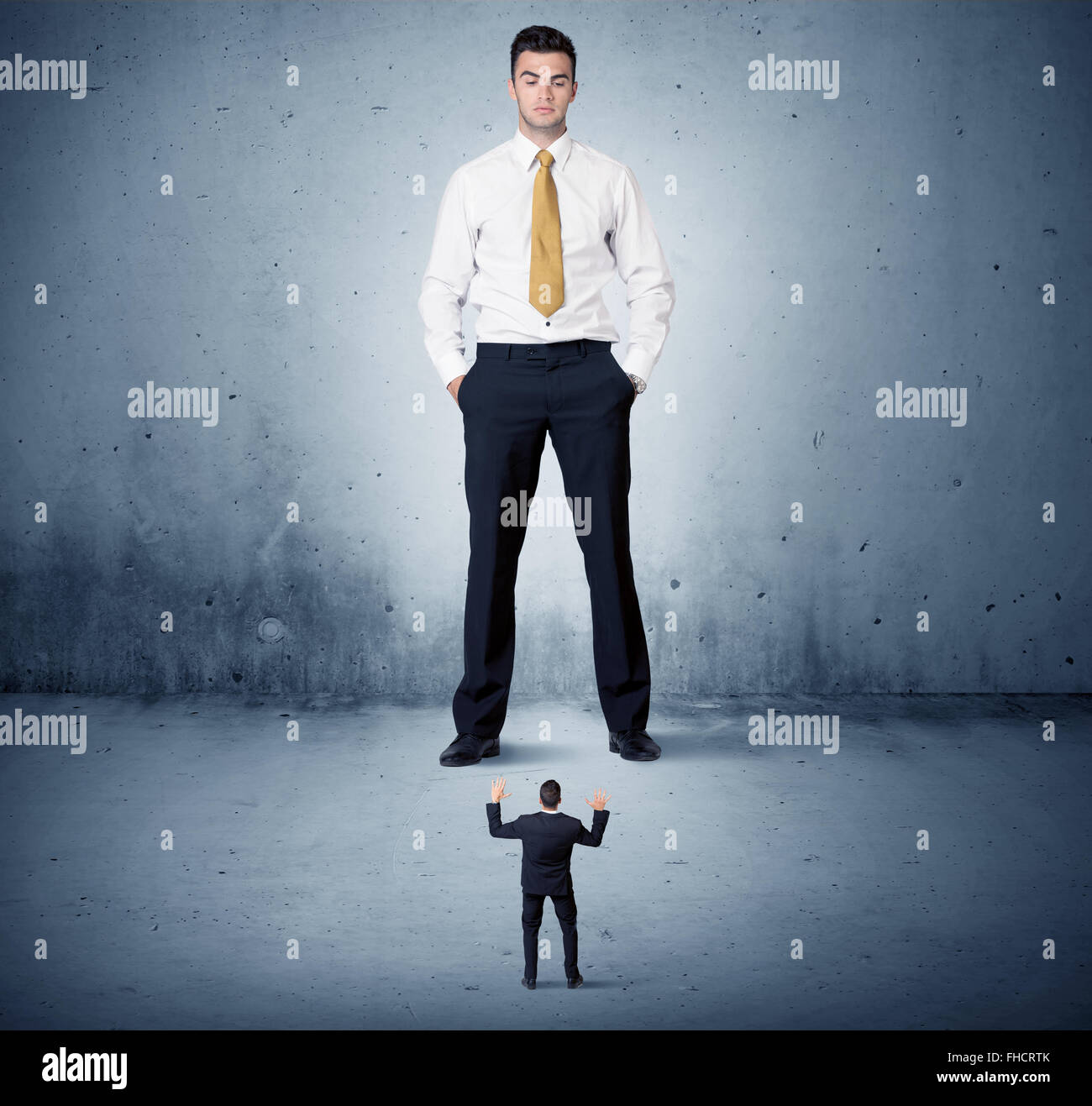 Angry huge business man lokking at small guy Stock Photo - Alamy