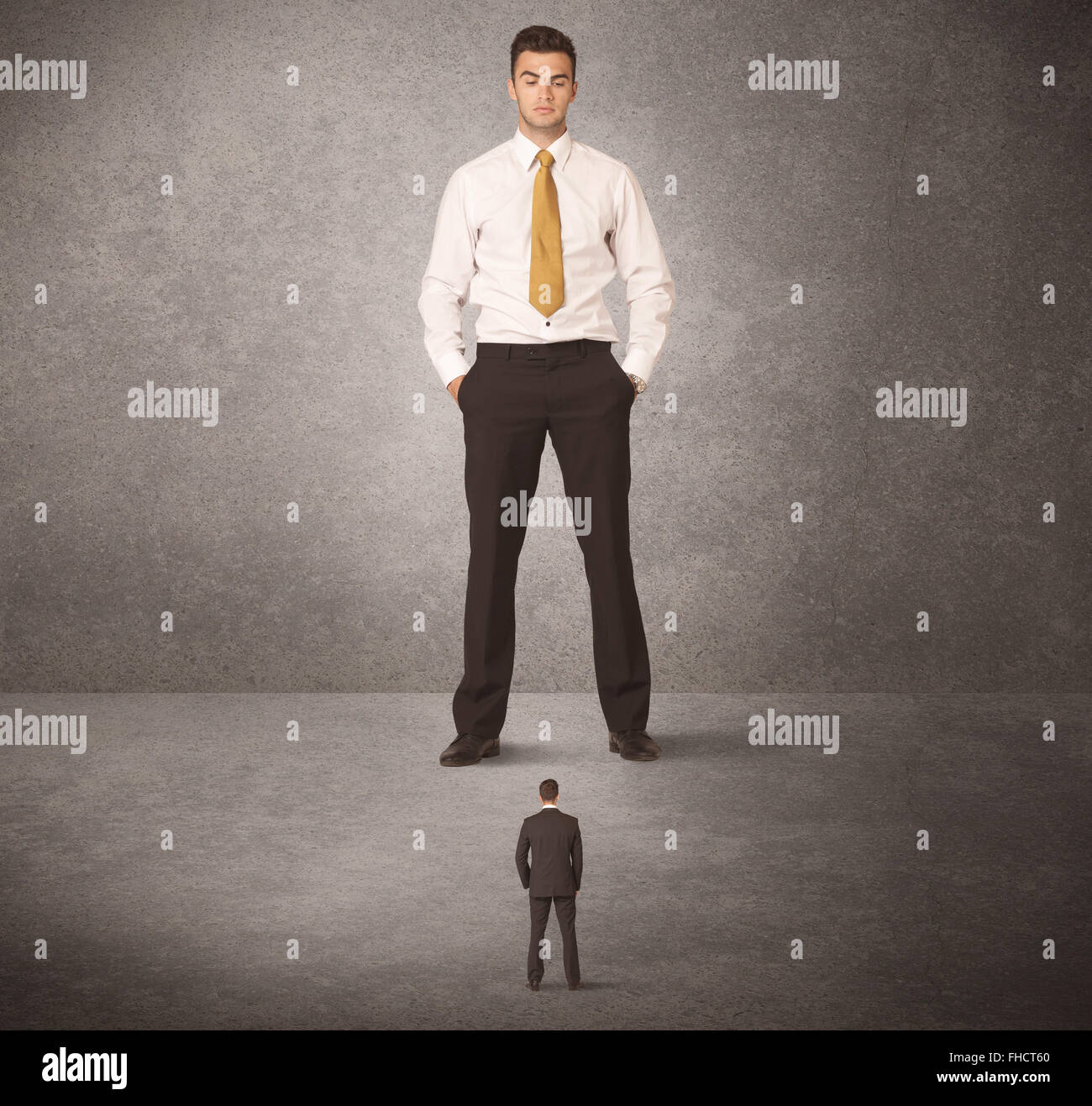 Big business man looking at small worker Stock Photo - Alamy