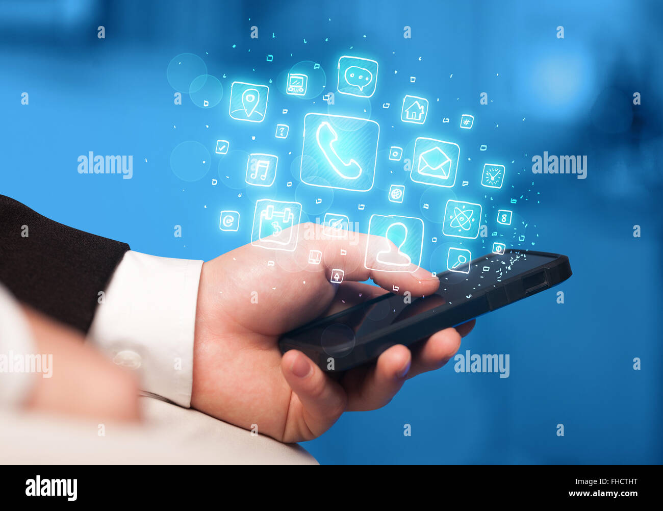 Hand holding smartphone with mobile app icons Stock Photo - Alamy