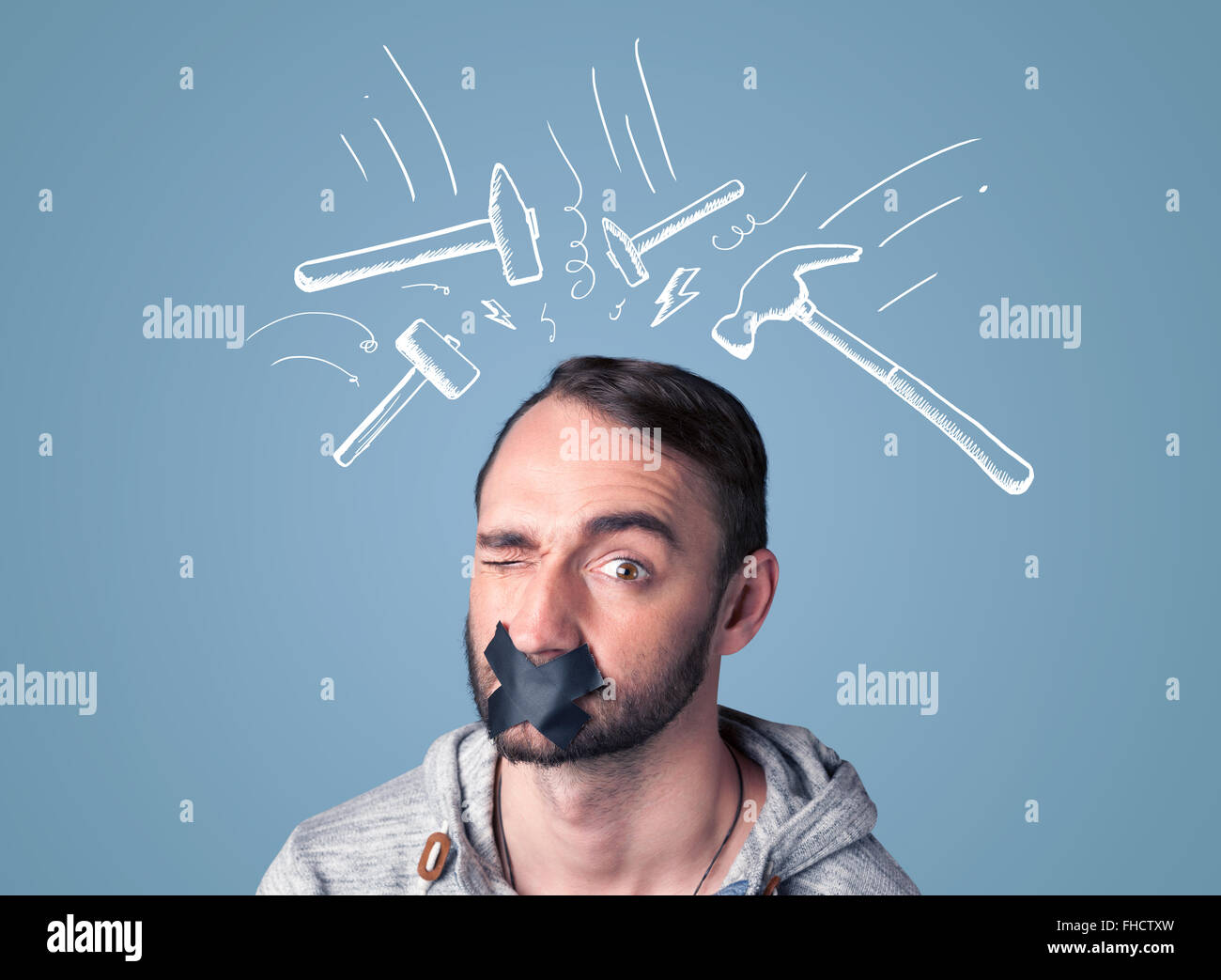 Young man with glued mouth and beating hammer marks Stock Photo - Alamy