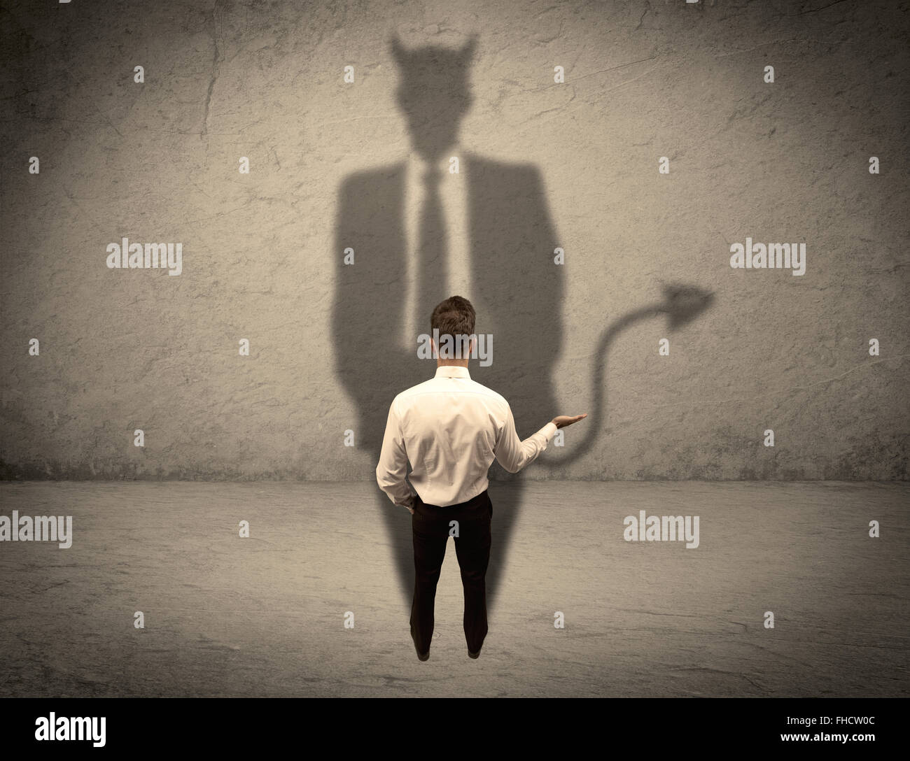 Salesman facing his own devil shadow Stock Photo - Alamy