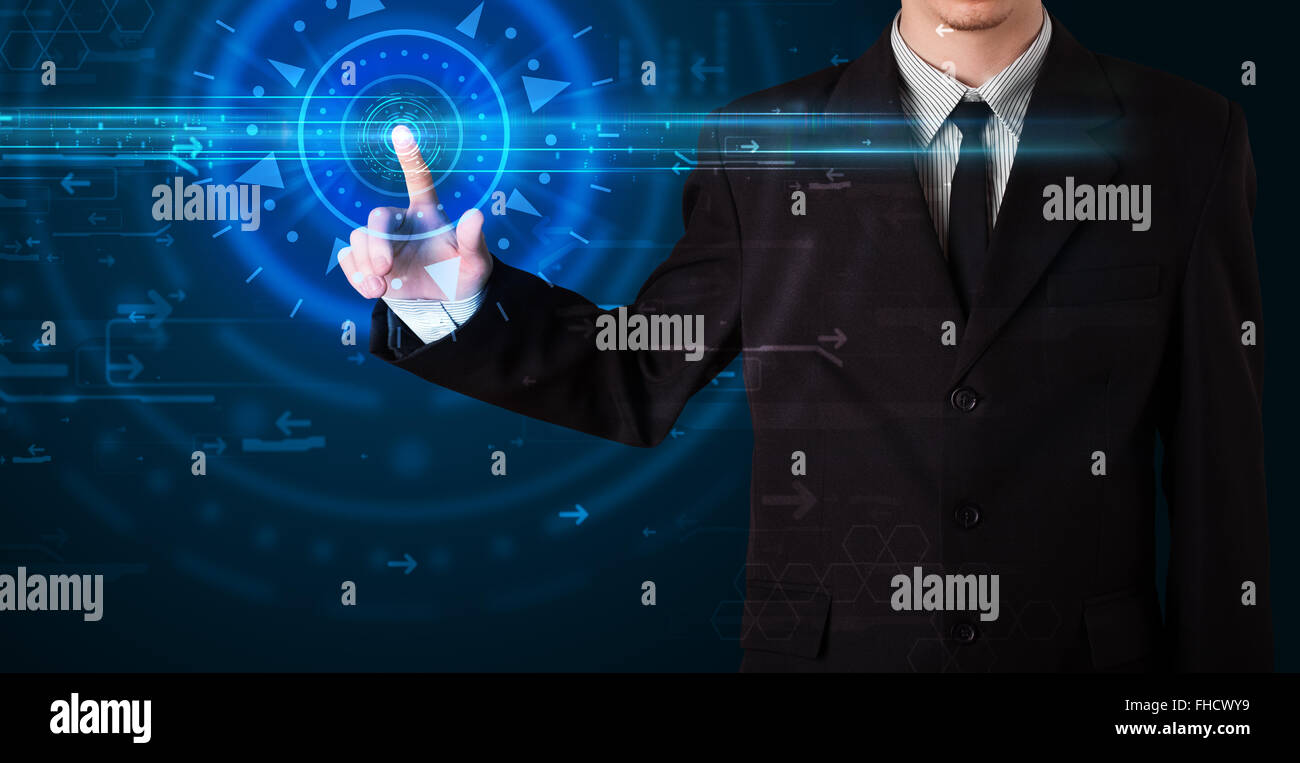 Handsome tech guy pressing high technology control panel screen concept ...
