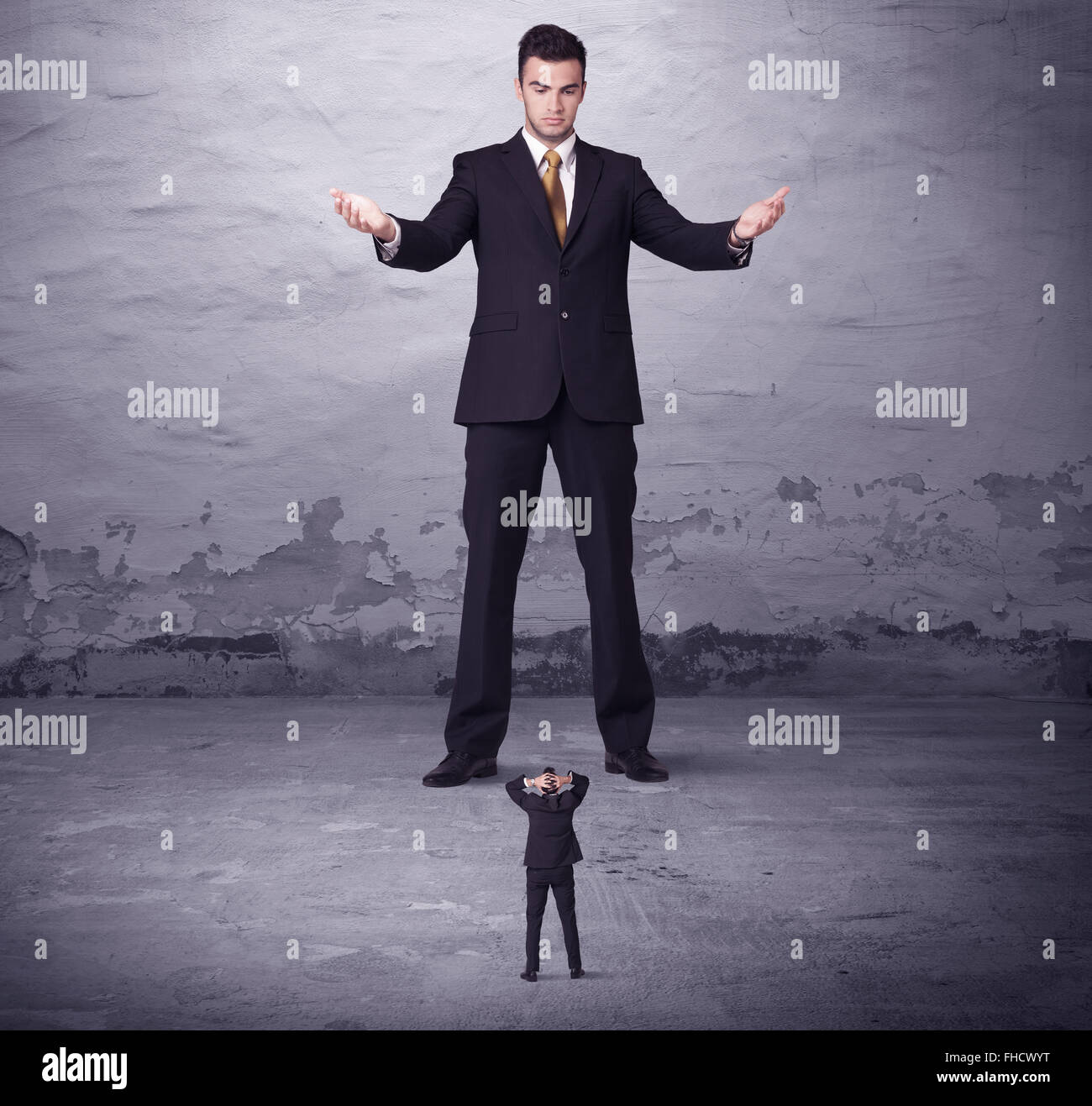 Angry big manager looking at small business man Stock Photo - Alamy