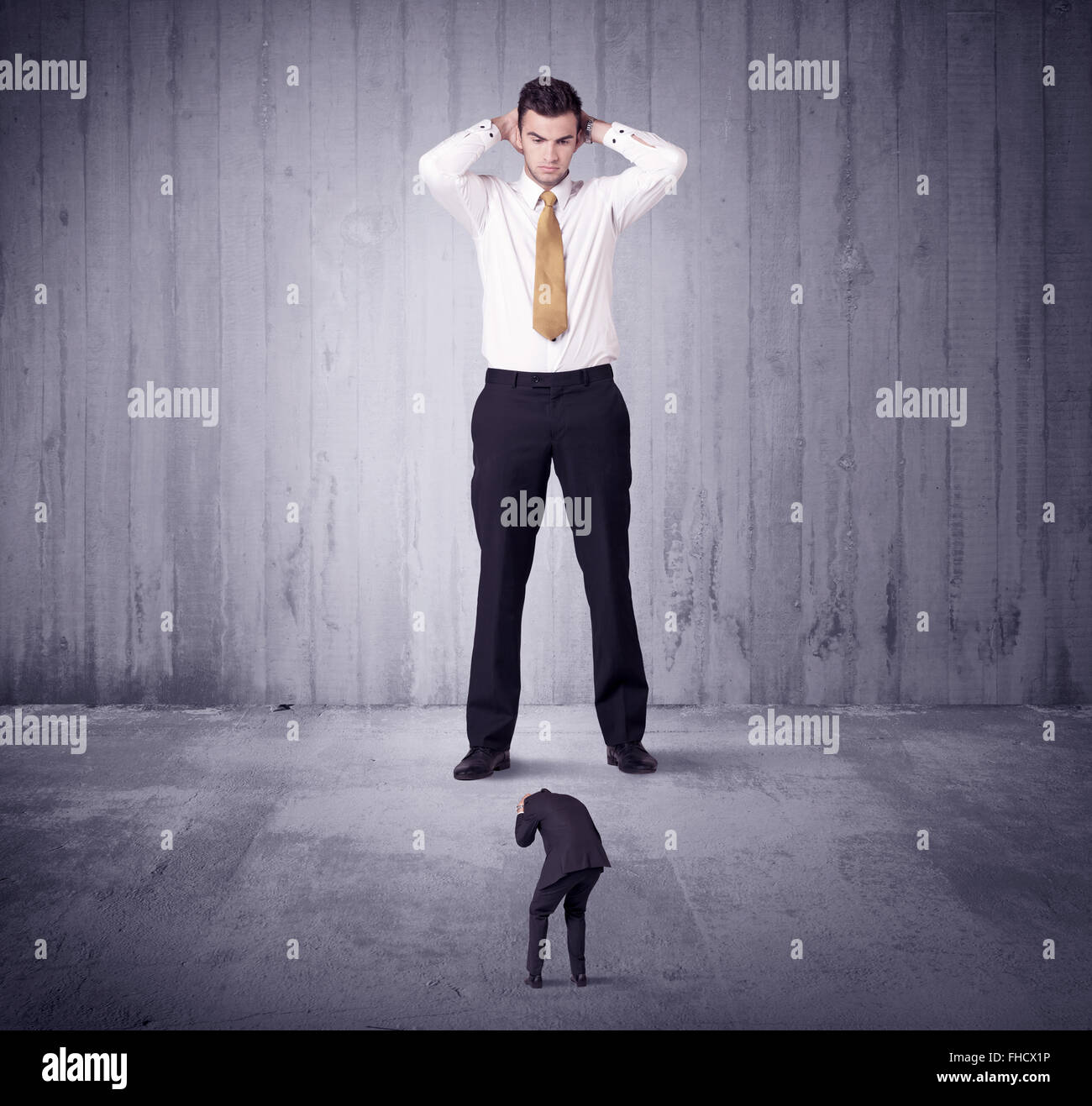 Huge boss lokking at small business man Stock Photo - Alamy