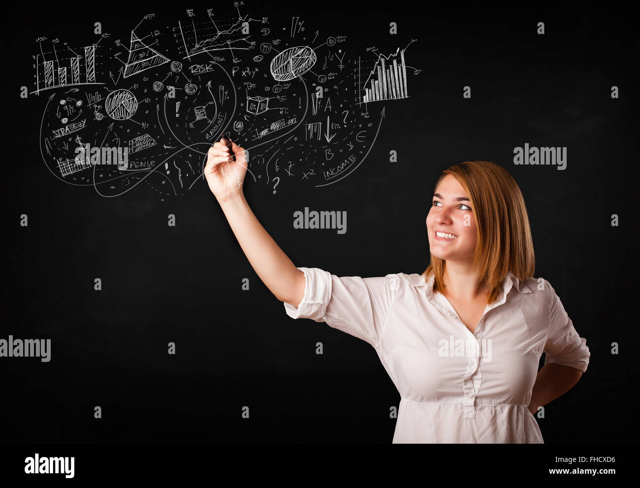 Pretty girl sketching graphs and diagrams on wall Stock Photo - Alamy