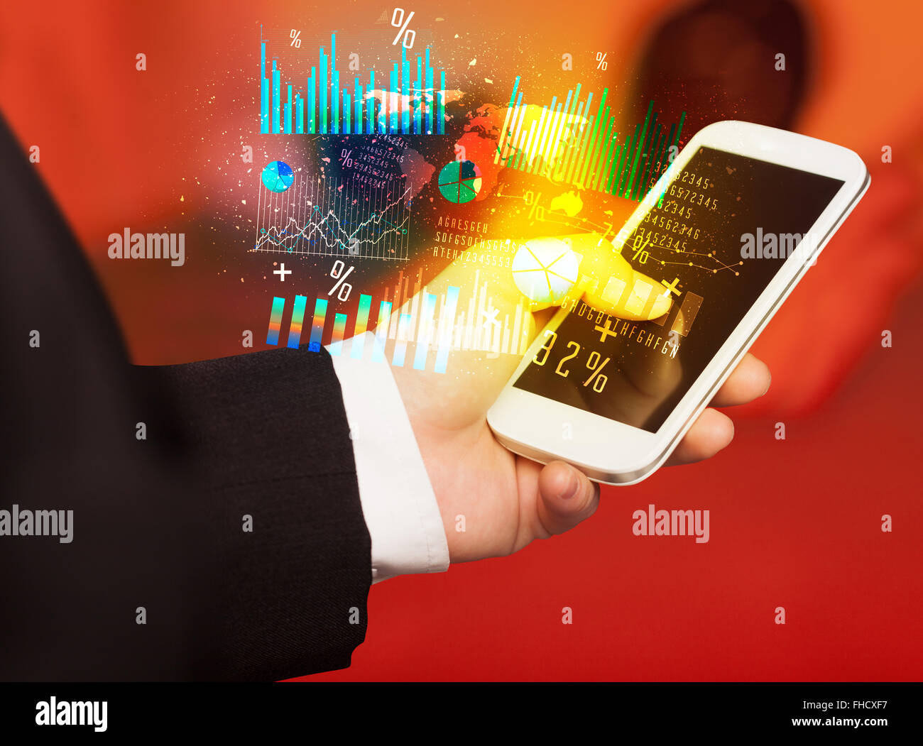 Hand holding smartphone with business diagrams Stock Photo - Alamy