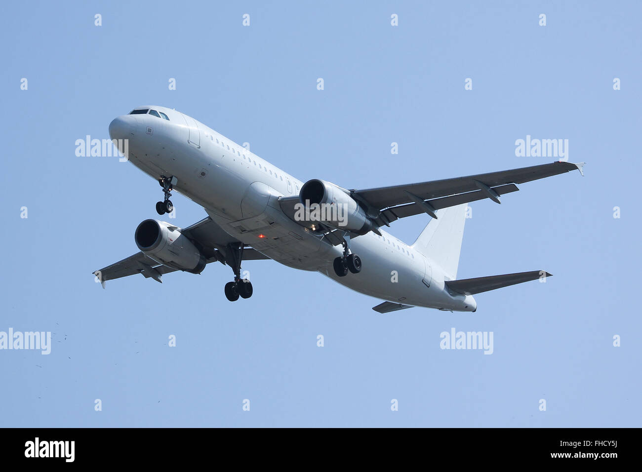 White Airplane landing with Blue sky, Airbus A320 Stock Photo - Alamy
