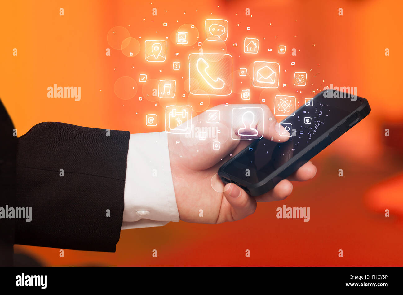 Hand holding smartphone with mobile app icons Stock Photo - Alamy
