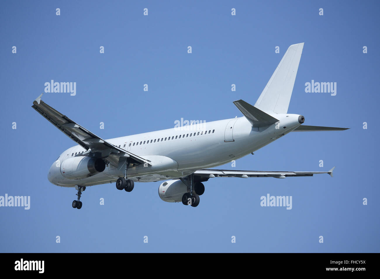 White Airplane landing with Blue sky, Airbus A320 Stock Photo - Alamy