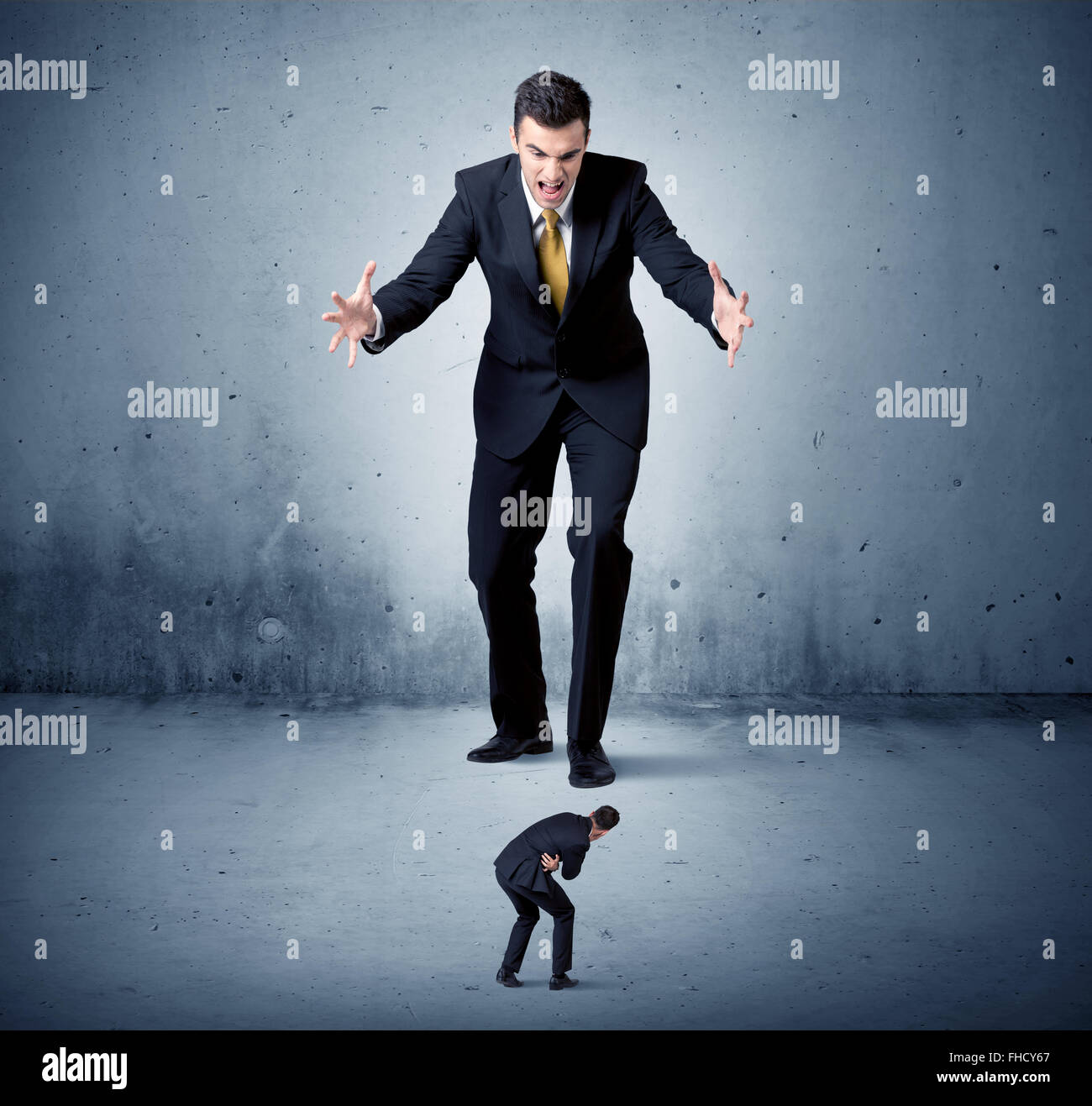 Angry huge business man lokking at small guy Stock Photo - Alamy
