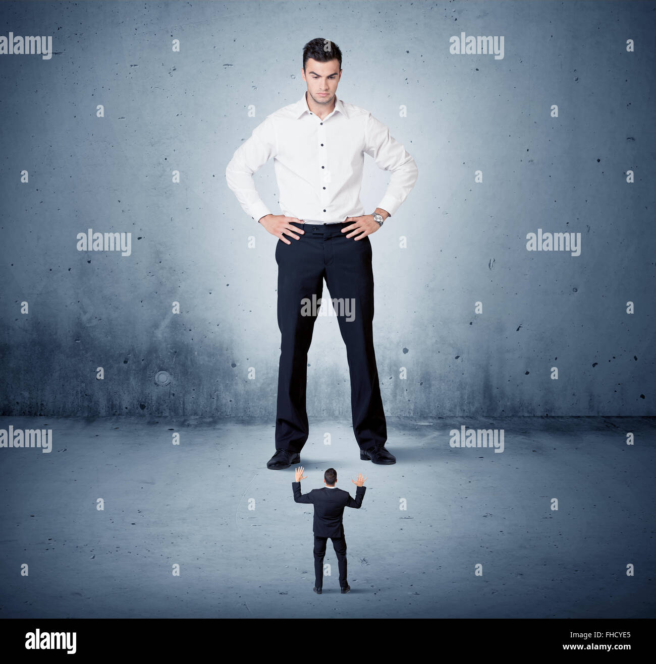 Angry huge business man lokking at small guy Stock Photo - Alamy