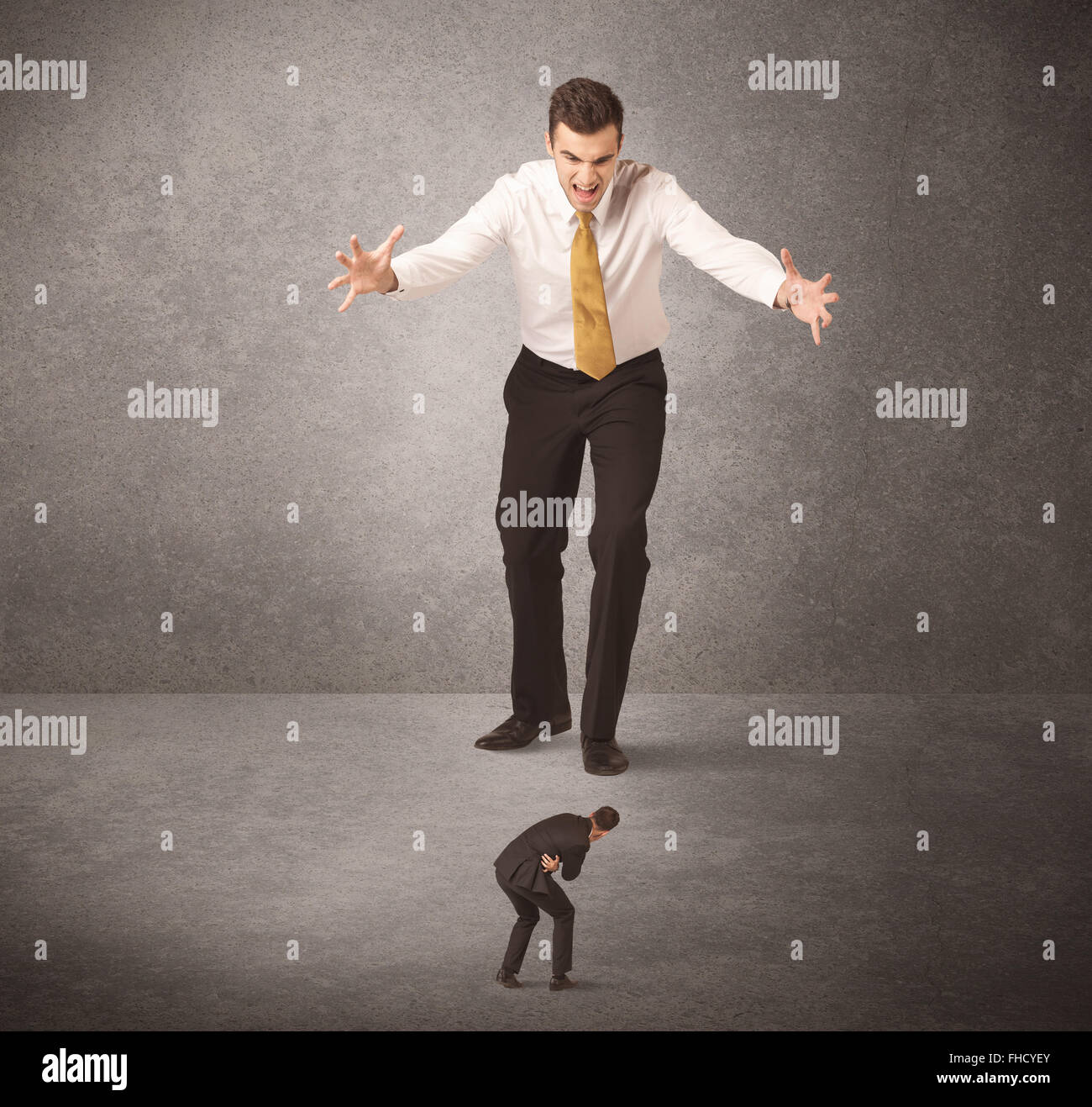 Big business man looking at small worker Stock Photo - Alamy