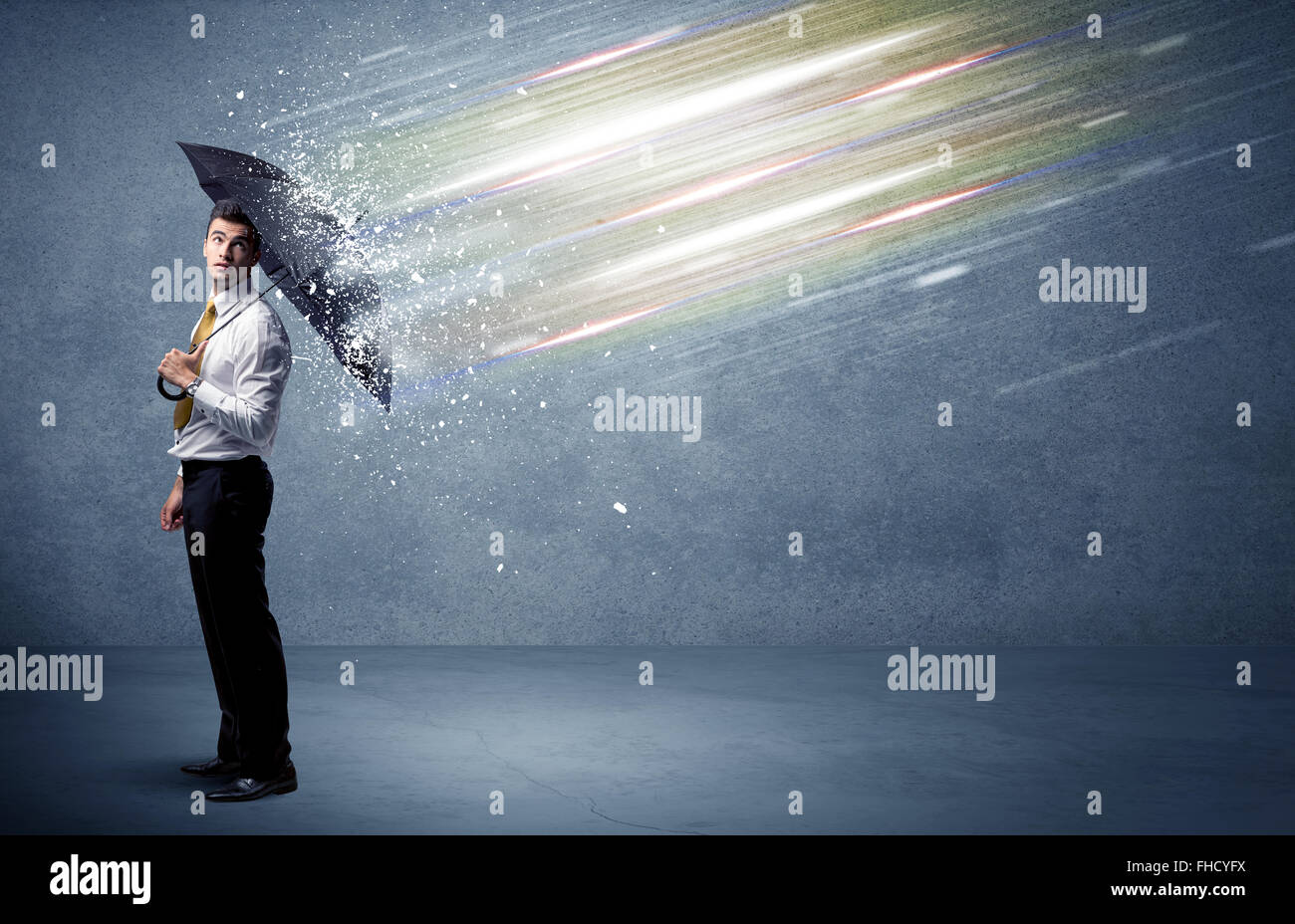 Business man defending light beams with umbrella concept Stock Photo ...