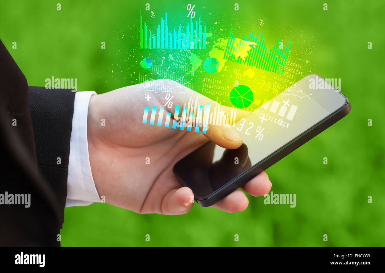 Hand holding smartphone with business diagrams Stock Photo - Alamy