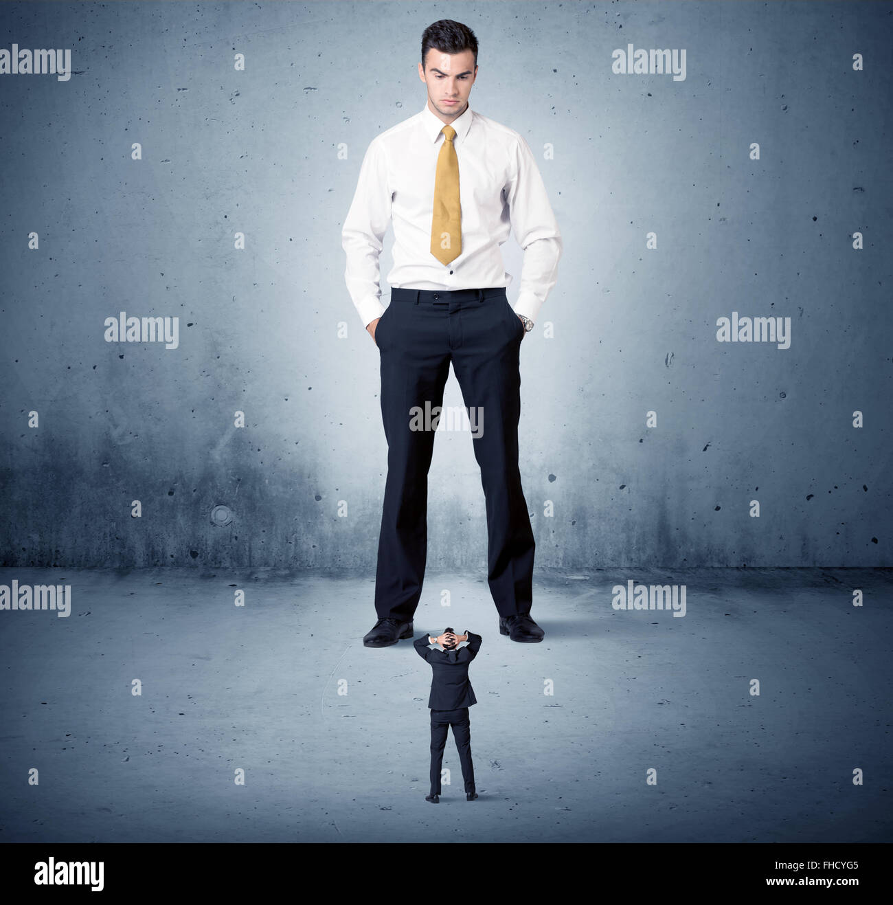 Angry huge business man lokking at small guy Stock Photo - Alamy