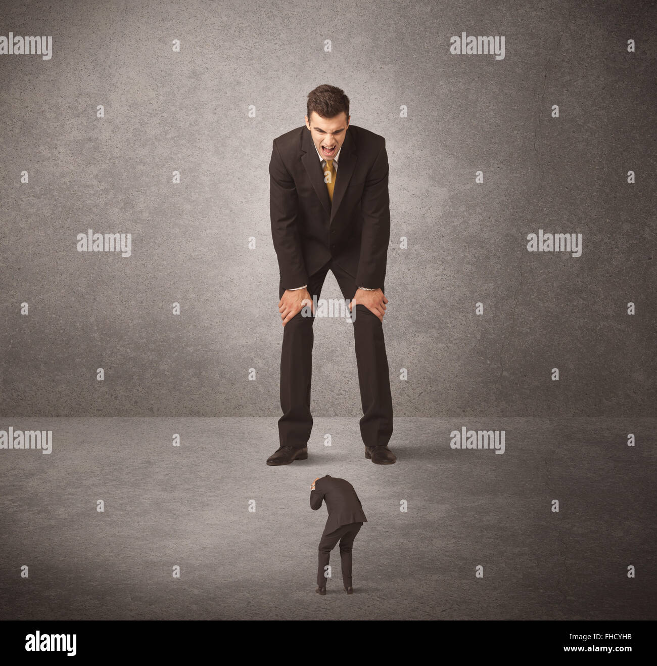 Big business man looking at small worker Stock Photo - Alamy