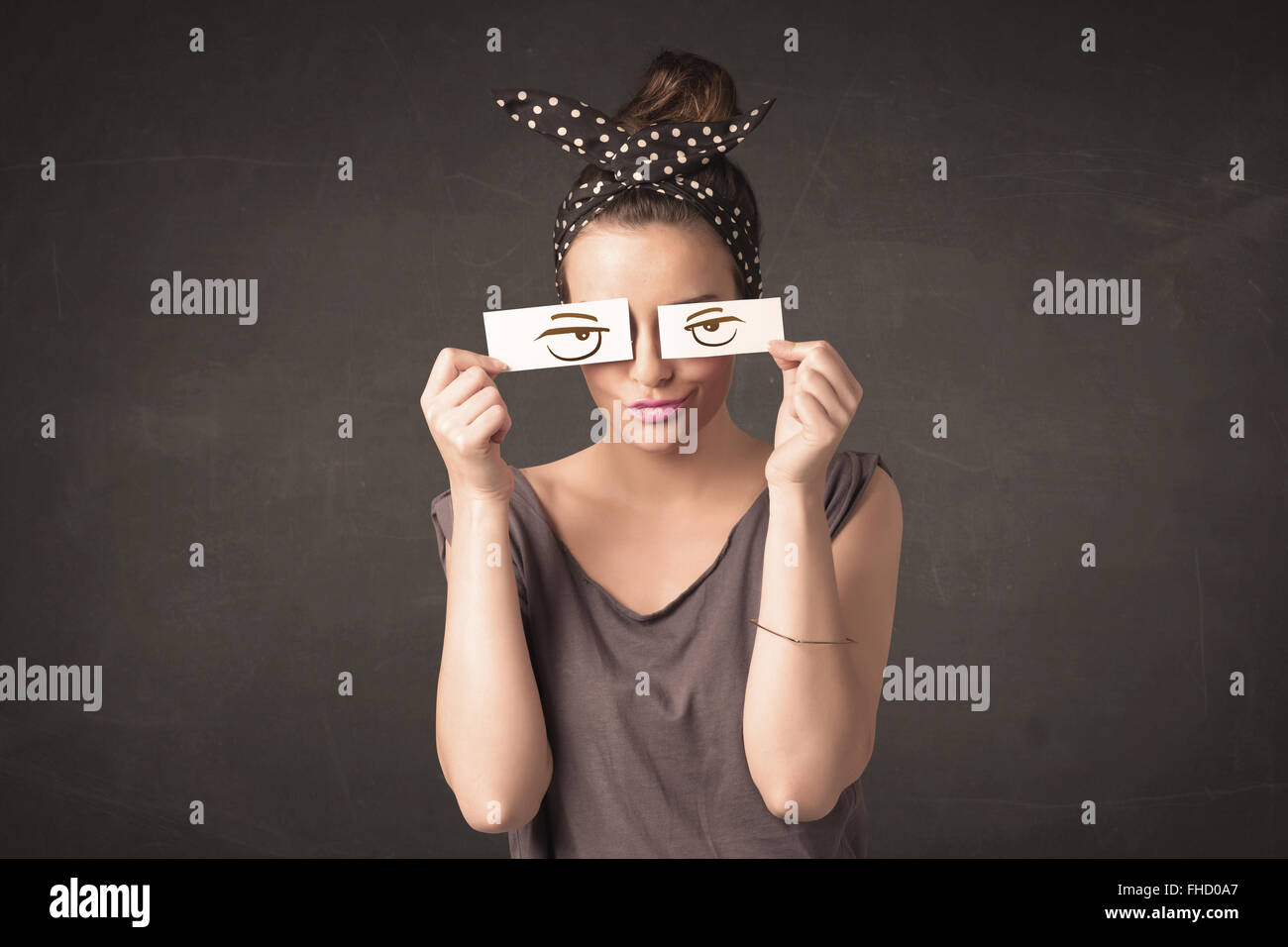 Young person holding paper with angry eye drawing Stock Photo - Alamy
