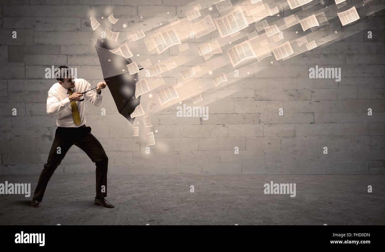 Business man protecting with umbrella against wind of papers Stock ...
