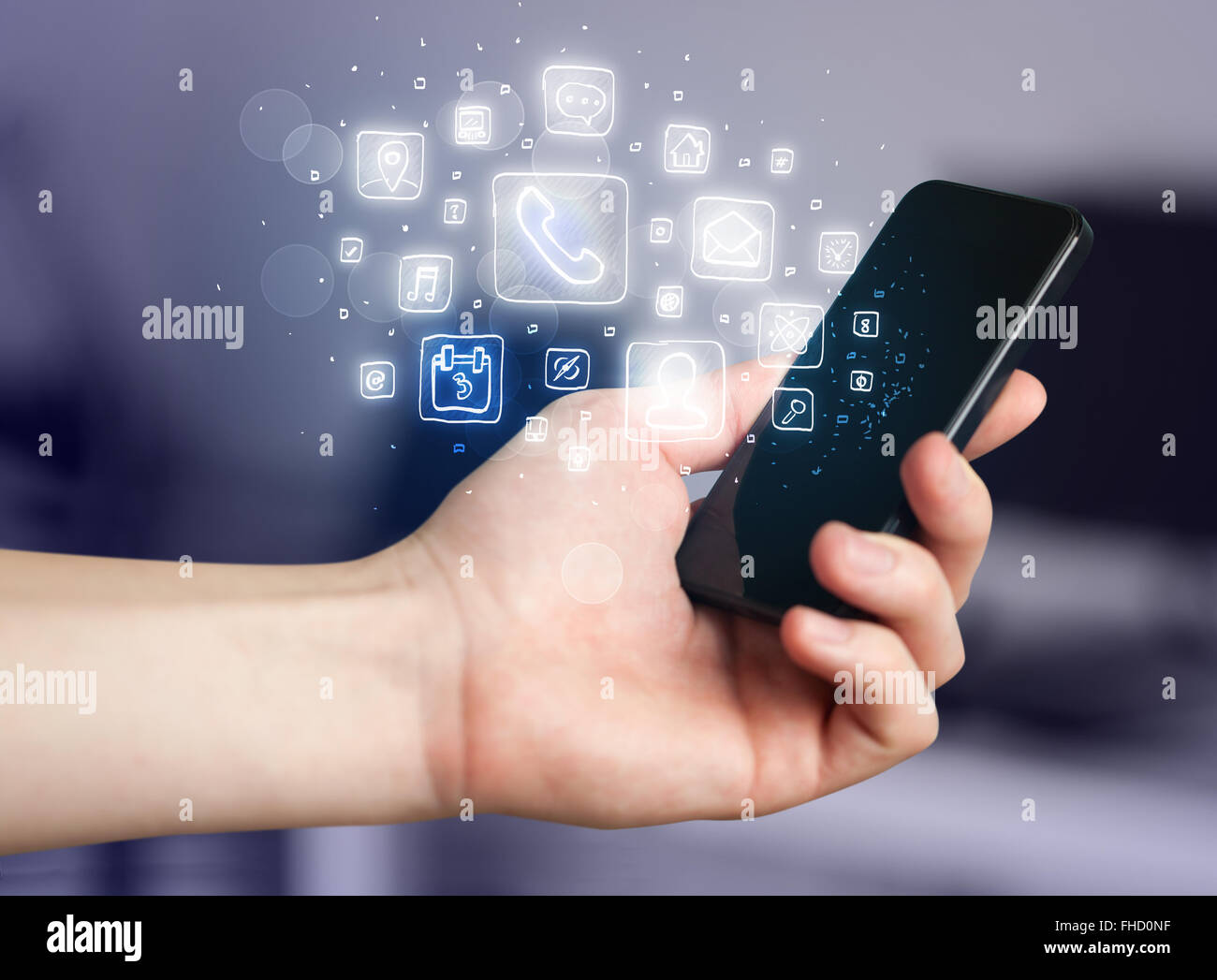 Hand holding smartphone with mobile app icons Stock Photo - Alamy