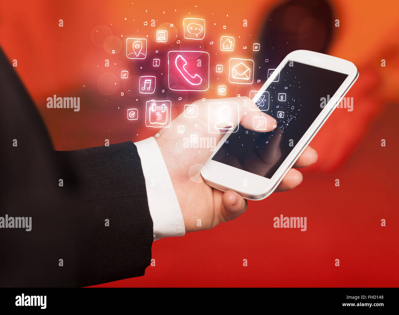 Hand holding smartphone with mobile app icons Stock Photo - Alamy