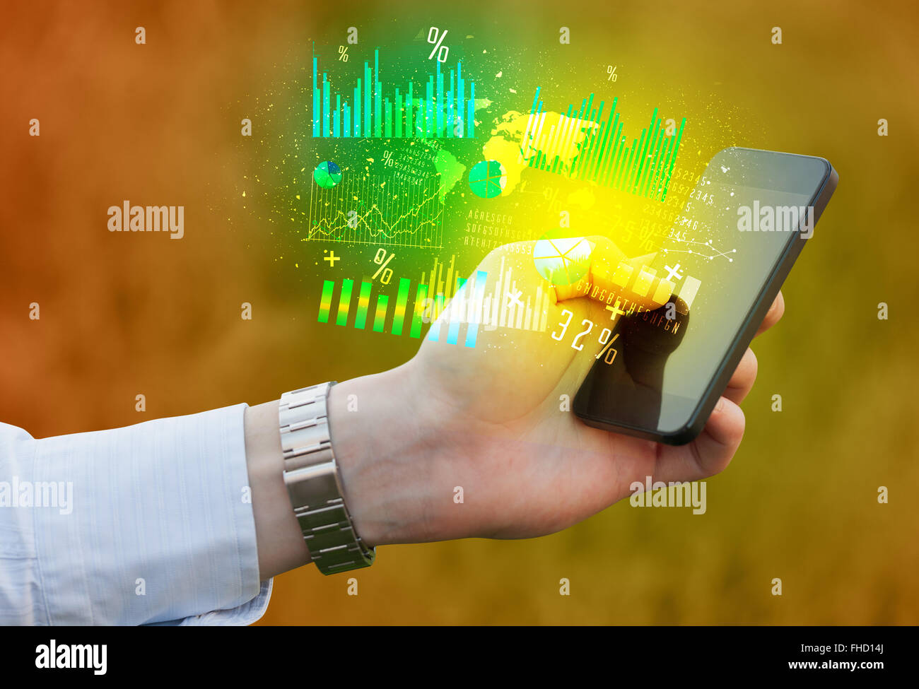 Hand holding smartphone with business diagrams Stock Photo - Alamy