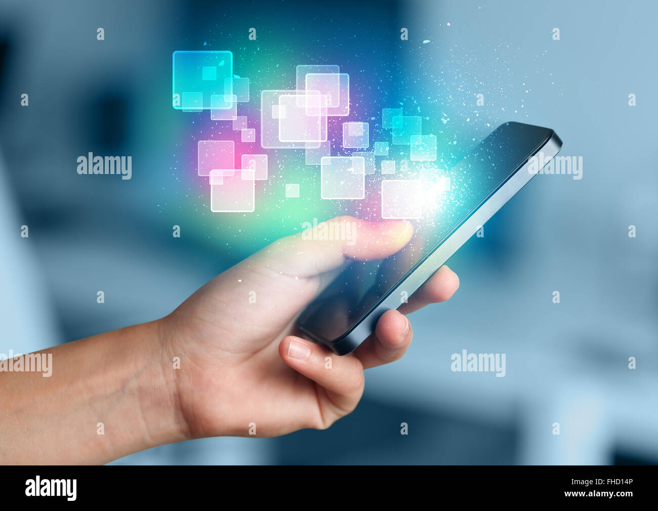 Hand holding smart phone with abstract glowing squares Stock Photo - Alamy