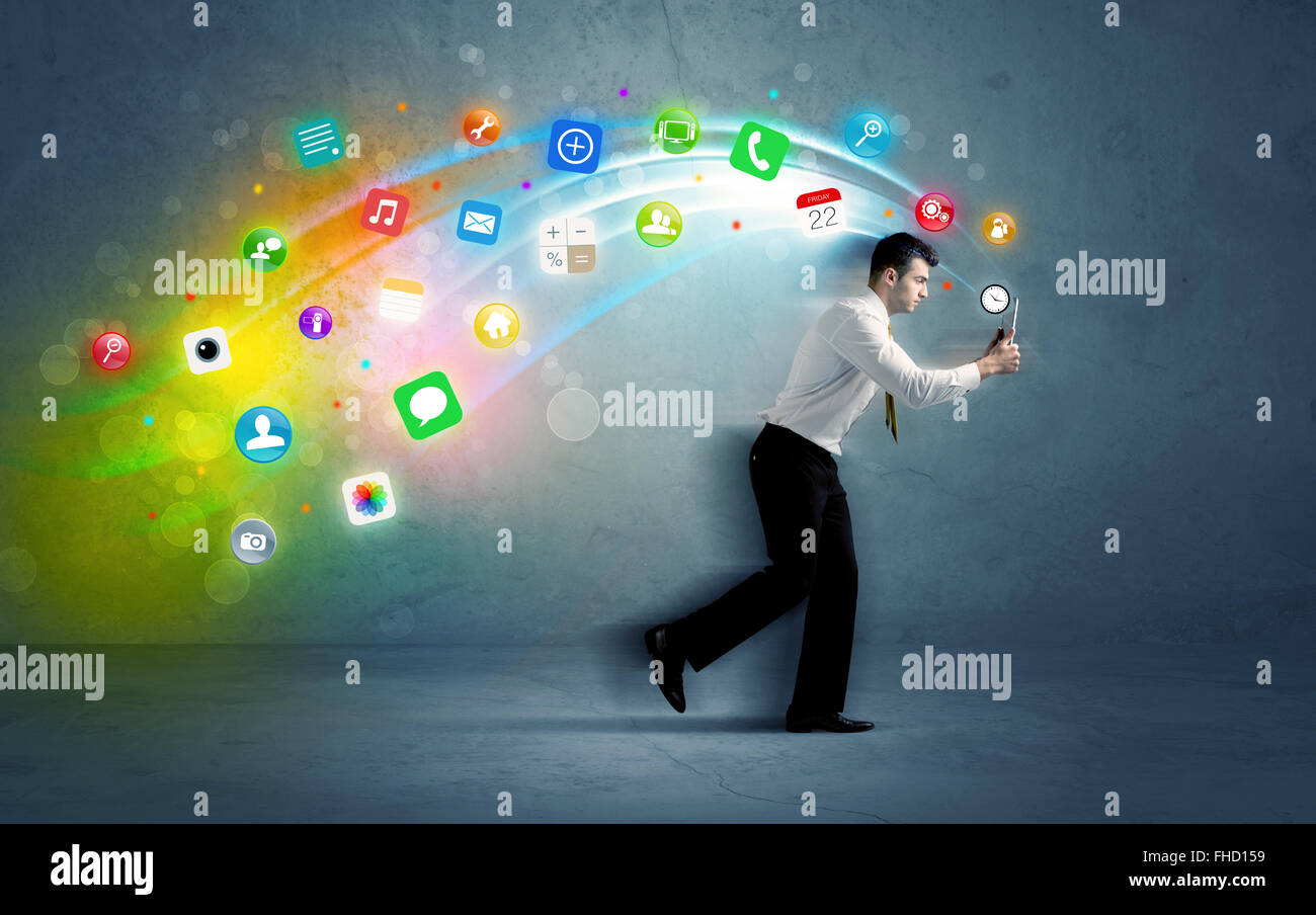 Running businessman with application icons from device Stock Photo - Alamy