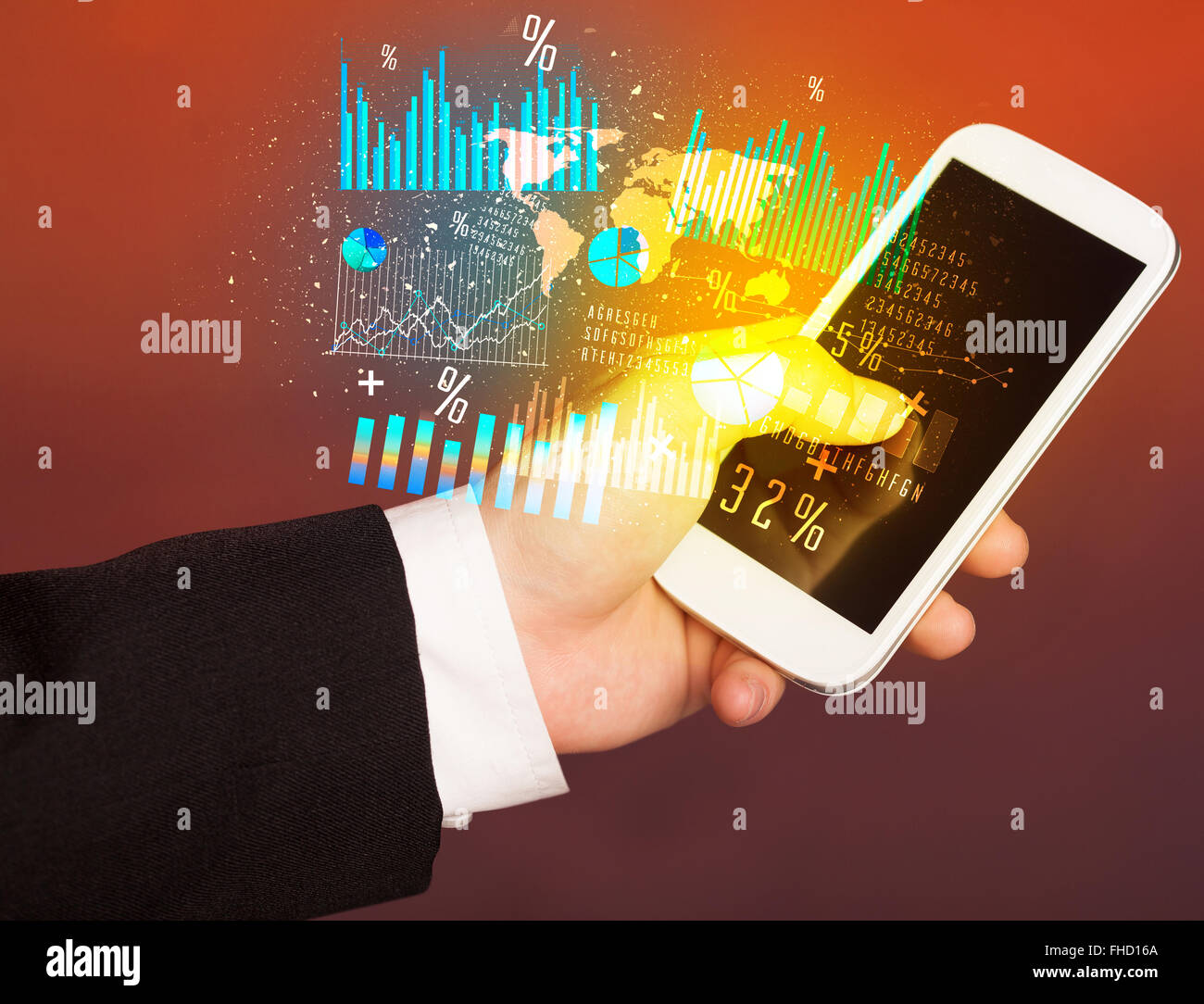 Hand holding smartphone with business diagrams Stock Photo - Alamy