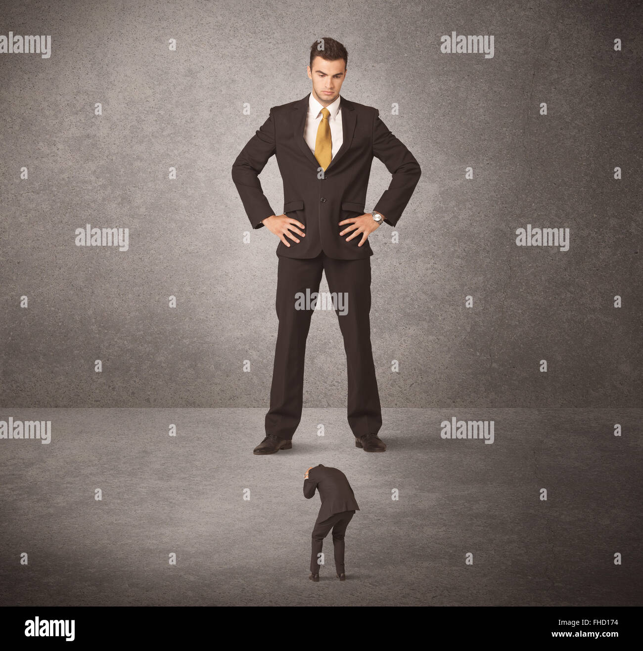 Big business man looking at small worker Stock Photo - Alamy