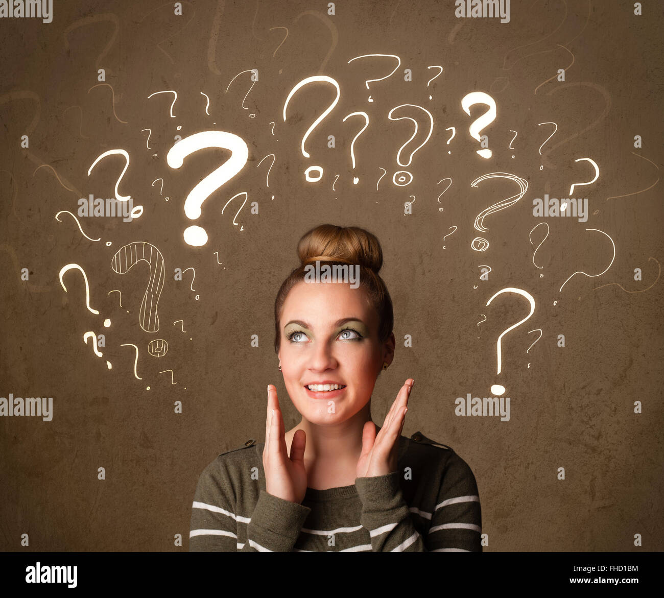 girl with question mark symbols around her head Stock Photo - Alamy