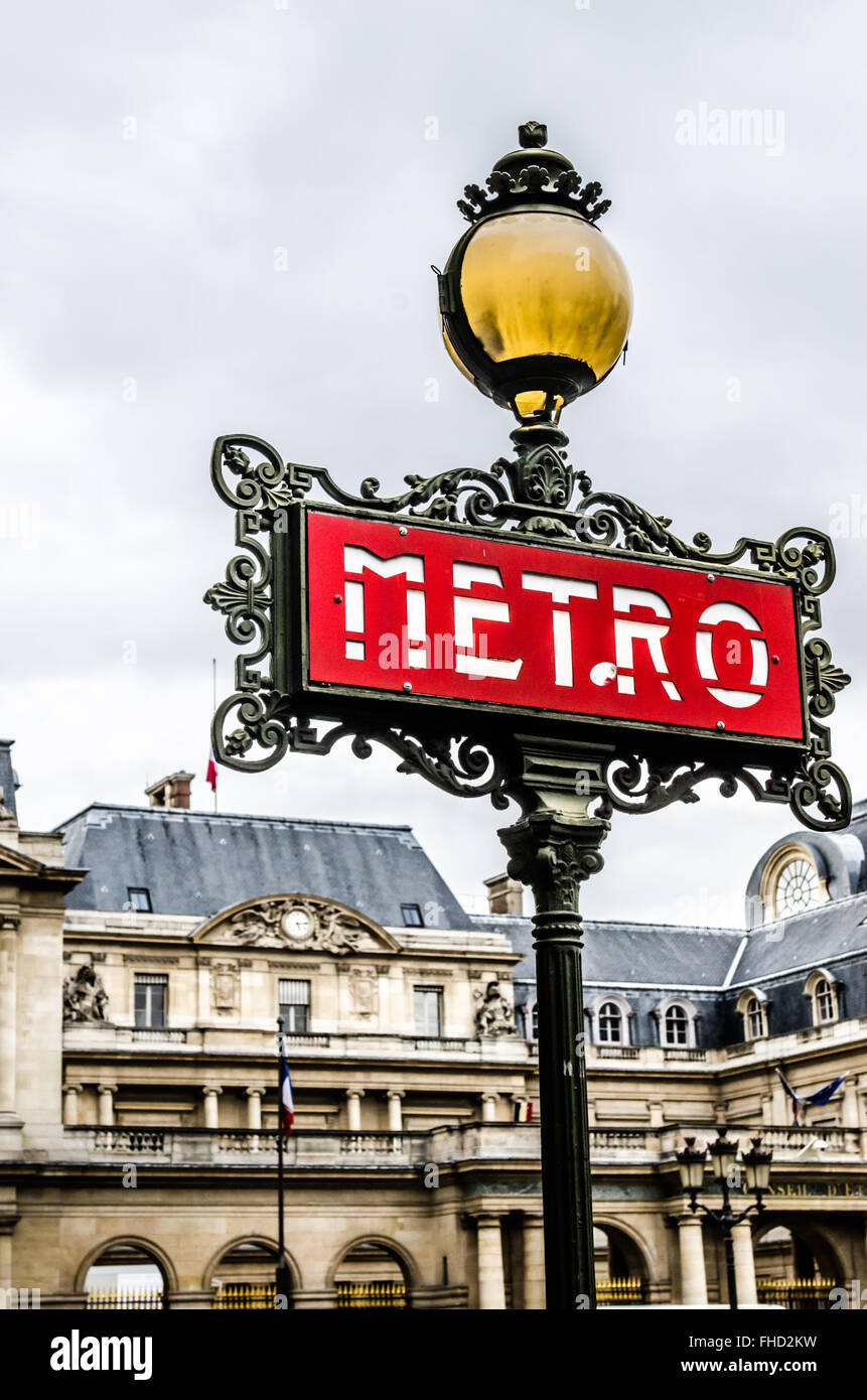 traditional Paris red metro sign against the backdrop of the building ...